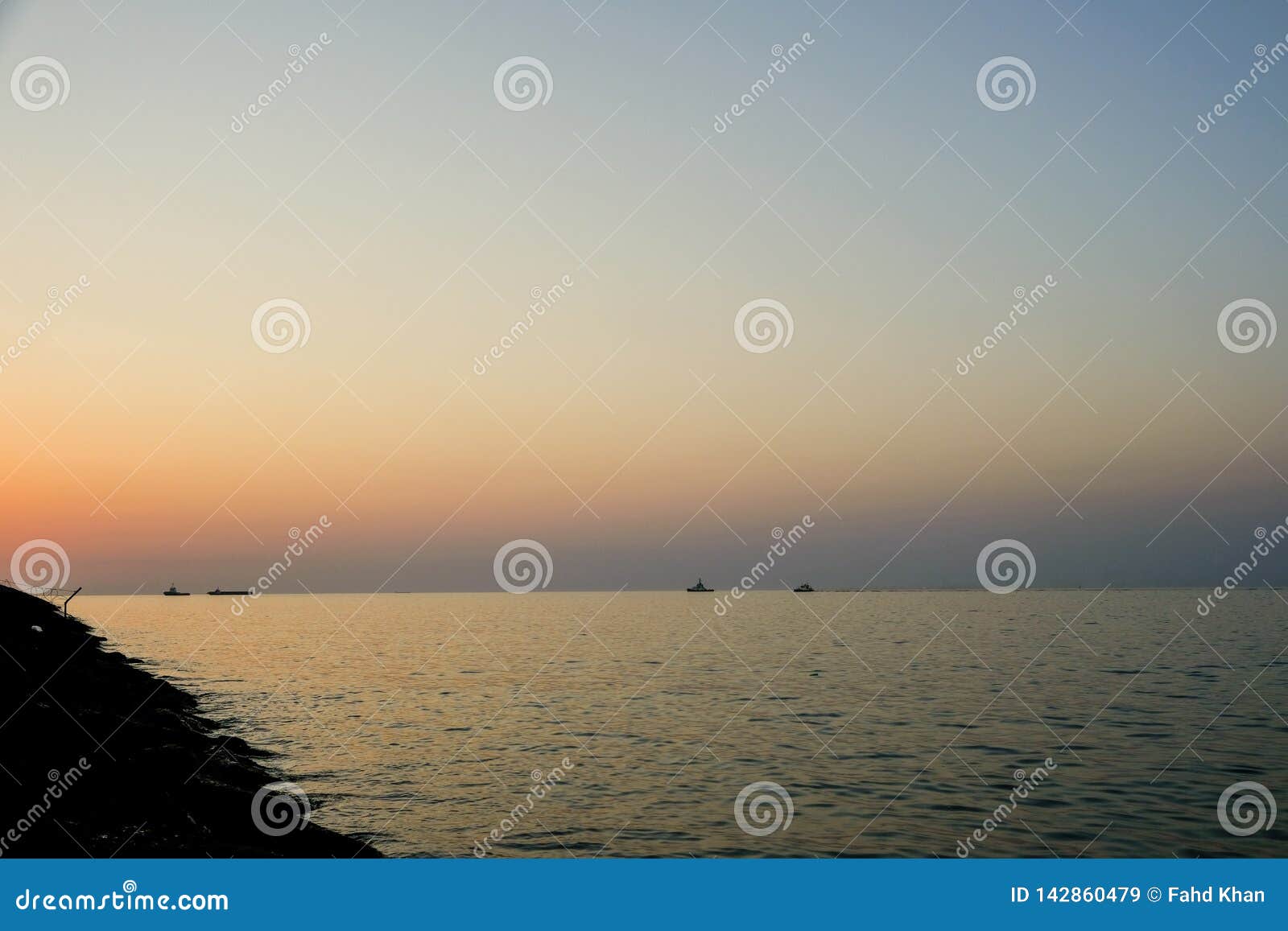 Distant Cargo Ships in a Calm Sea at Evening Stock Image - Image of ...