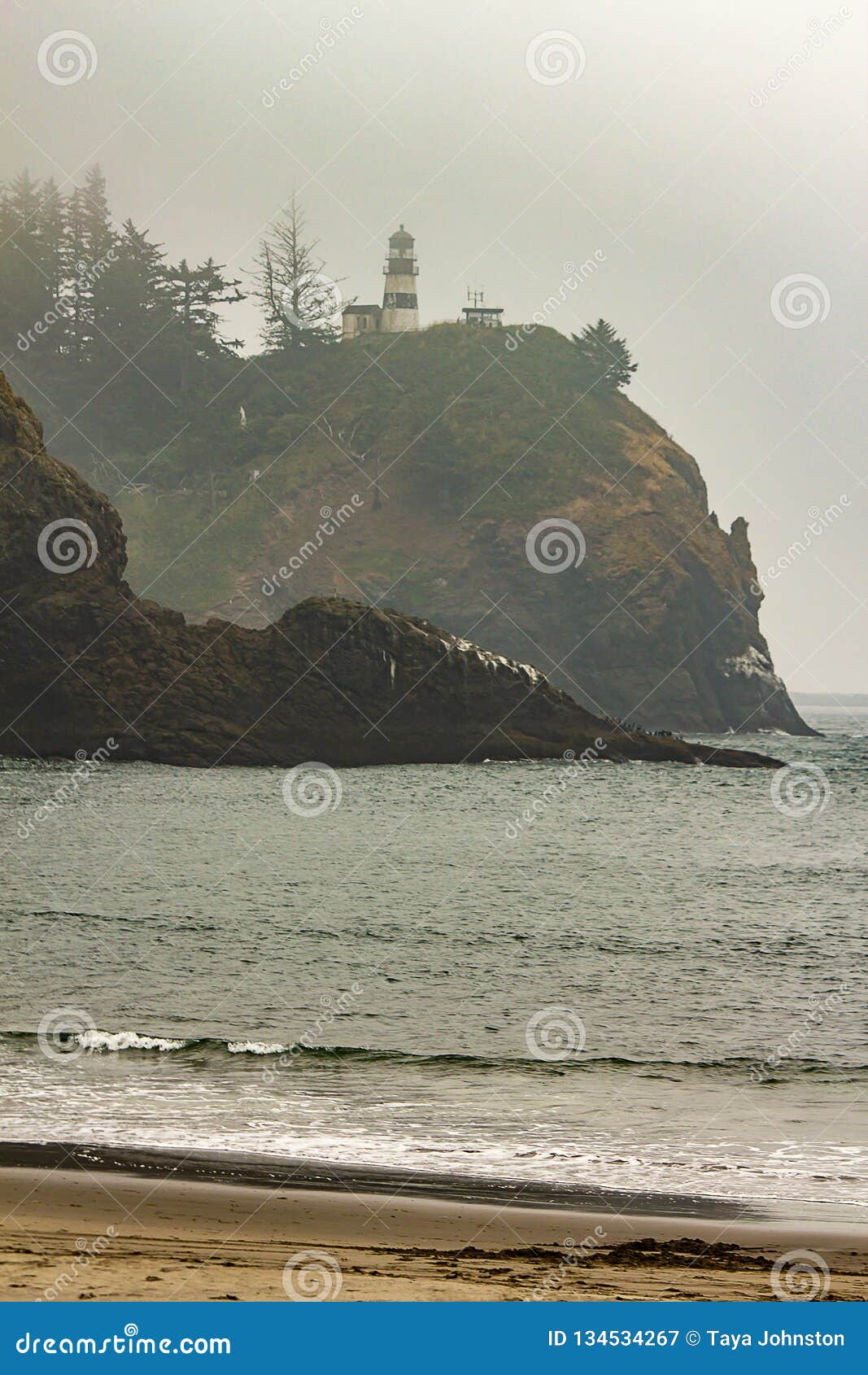 Distant Lighthouse on a Large Cliff Over a Cold Ocean Stock Image ...