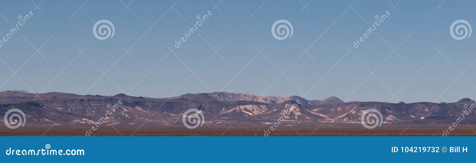 A Distant Mountain Range Under a Blue Sky Stock Photo - Image of ridge ...