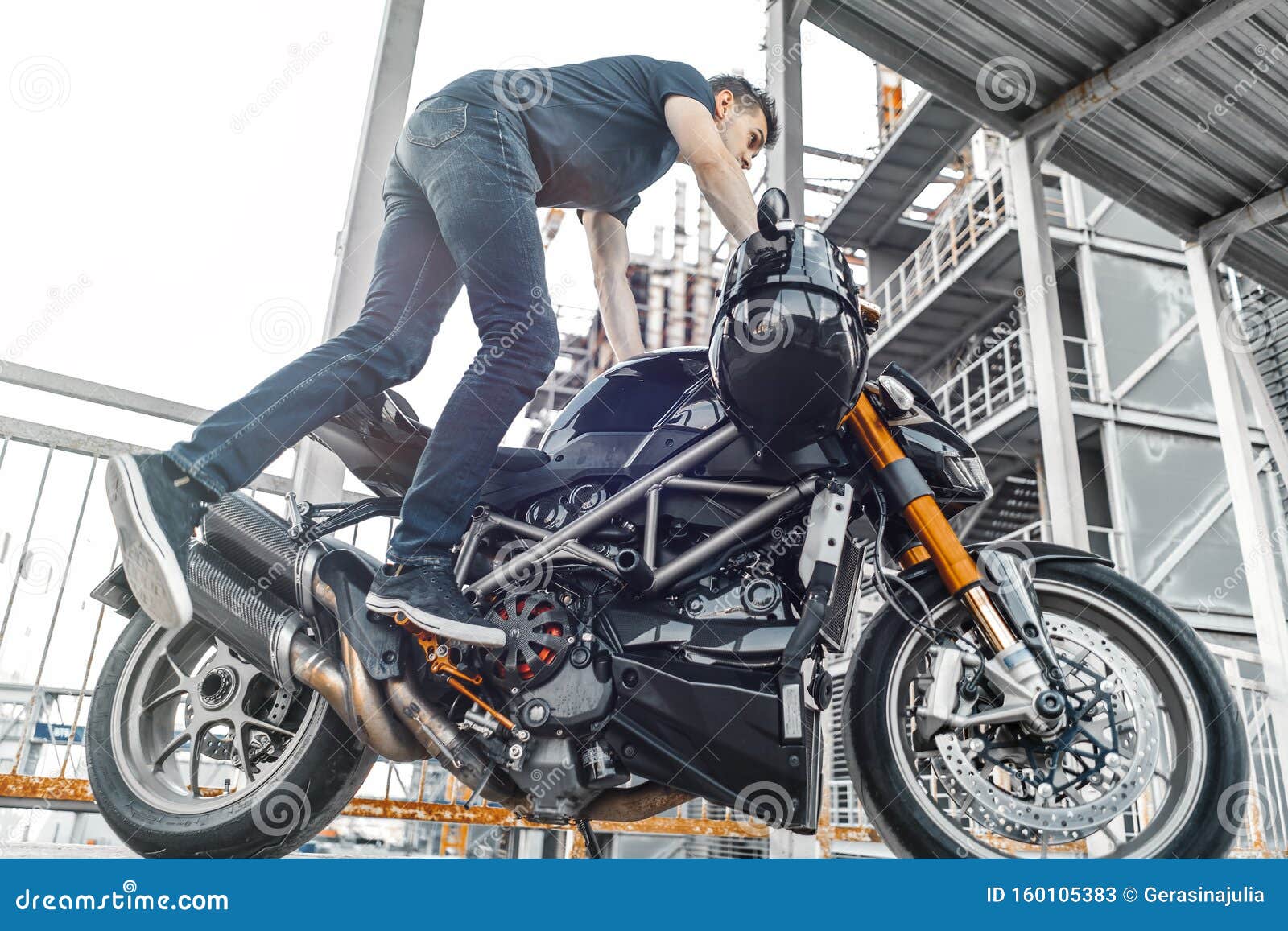 Handsome Biker Sitting Down on Motorcycle on Urban Background at ...