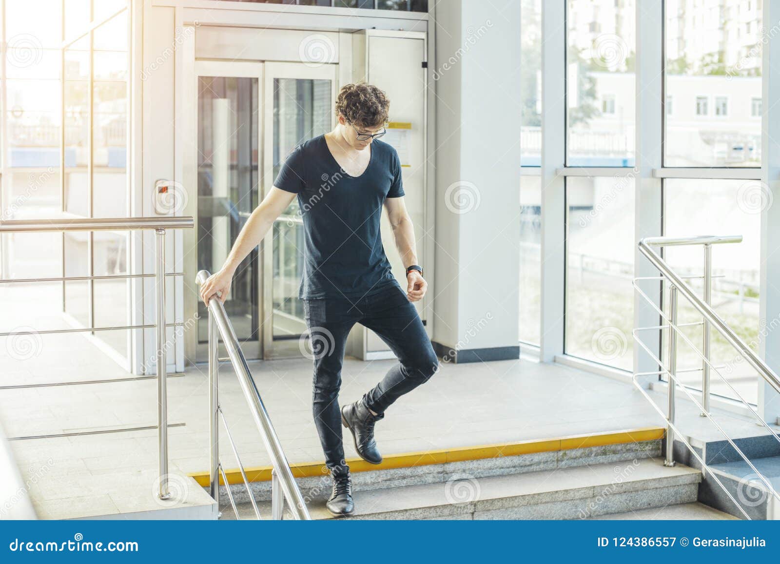 Distant Plan of Young Man Going Down the Stairs at the Railway Station ...