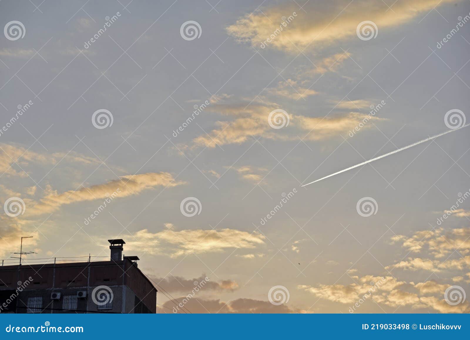 A Distant Plane Flying Across the Blue Sky Stock Photo - Image of blue ...