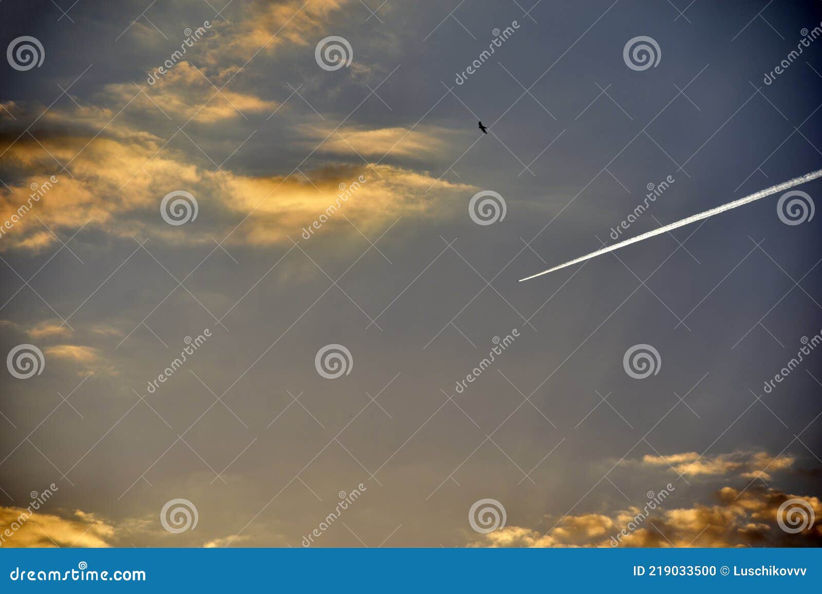 A Distant Plane Flying Across the Blue Sky Stock Photo - Image of ...