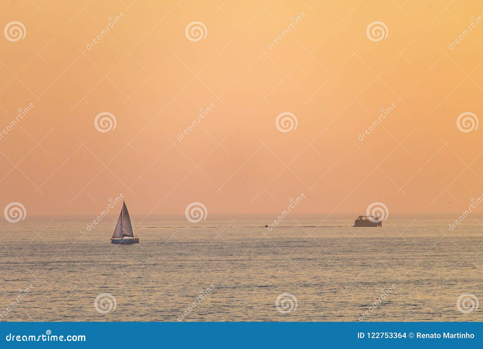 Distant Sailboat at Sunset stock photo. Image of sailing - 122753364