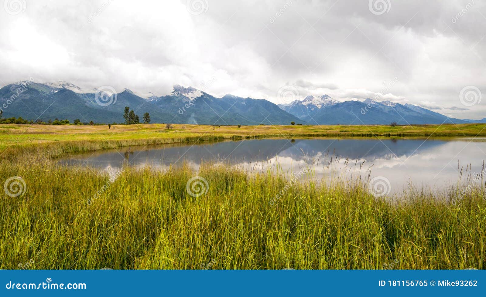 A Distant Snow Covered Mountain Range with a Lake Reflecting the ...