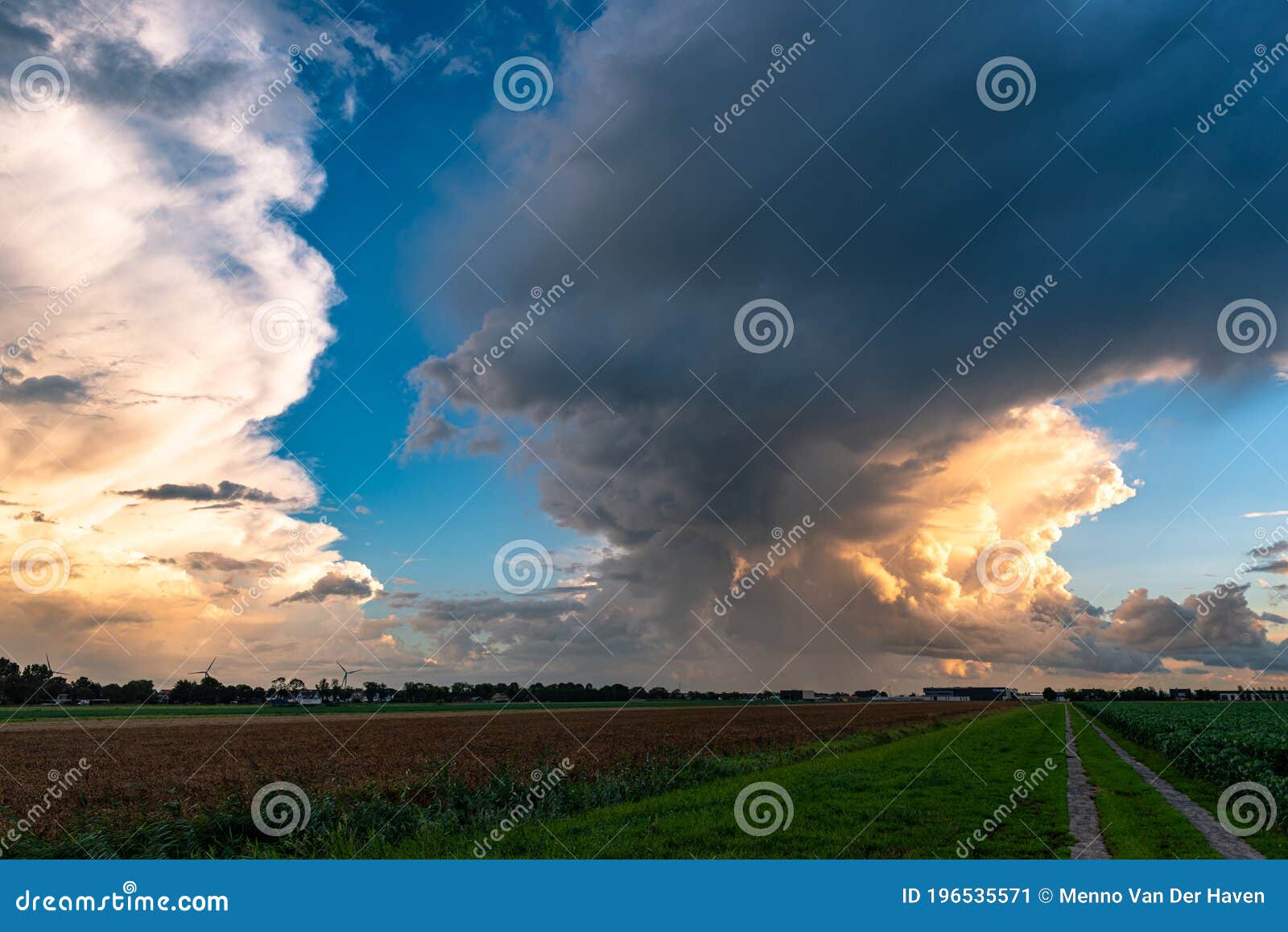 Distant Thunderstorms are Colorfully Lit by the Low Sun Stock Image ...