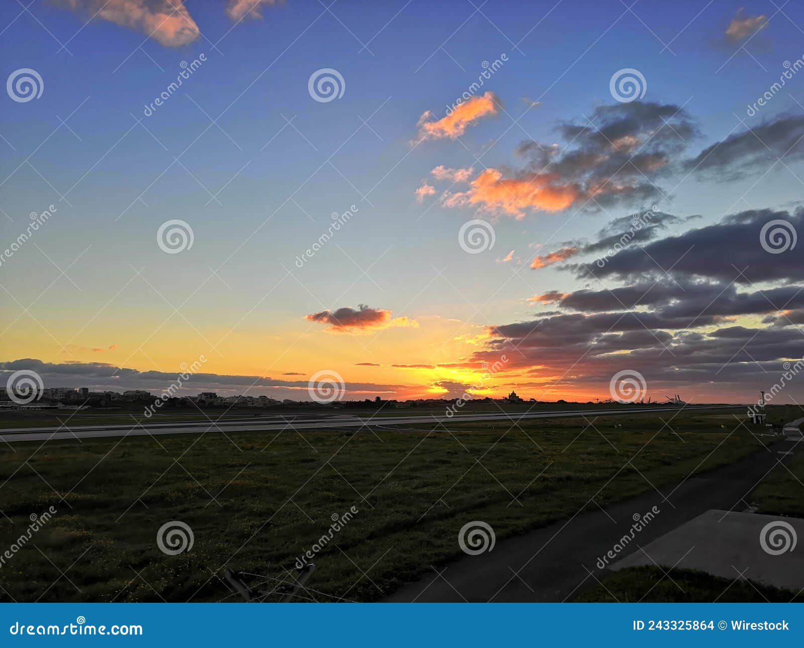 Distant View of the Sunset with Fields and Roads on the Foreground ...