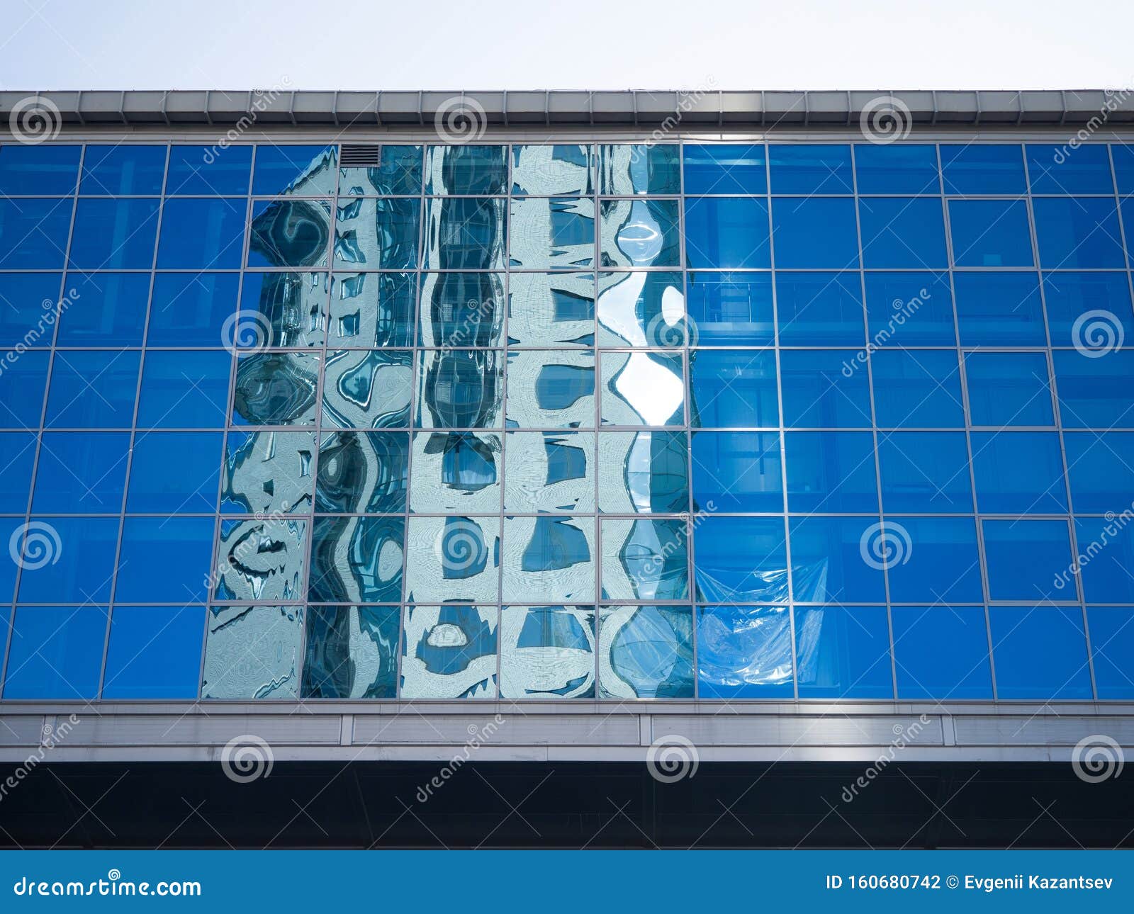 Distorted Architecture Reflected in Blue Glass Wall of Office Building ...