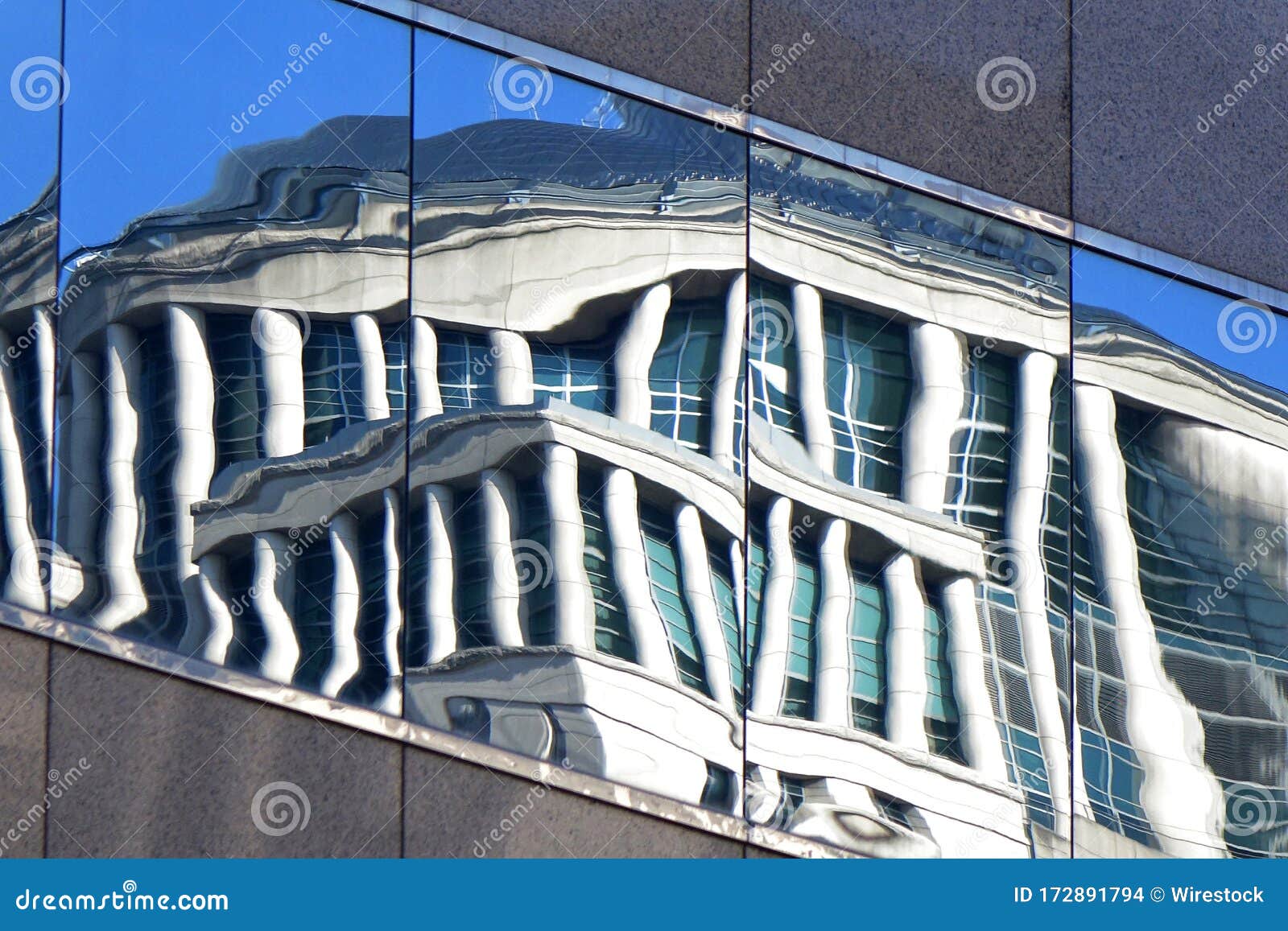 Distorted Reflection of a Building Facade on a Reflective Surface Stock ...