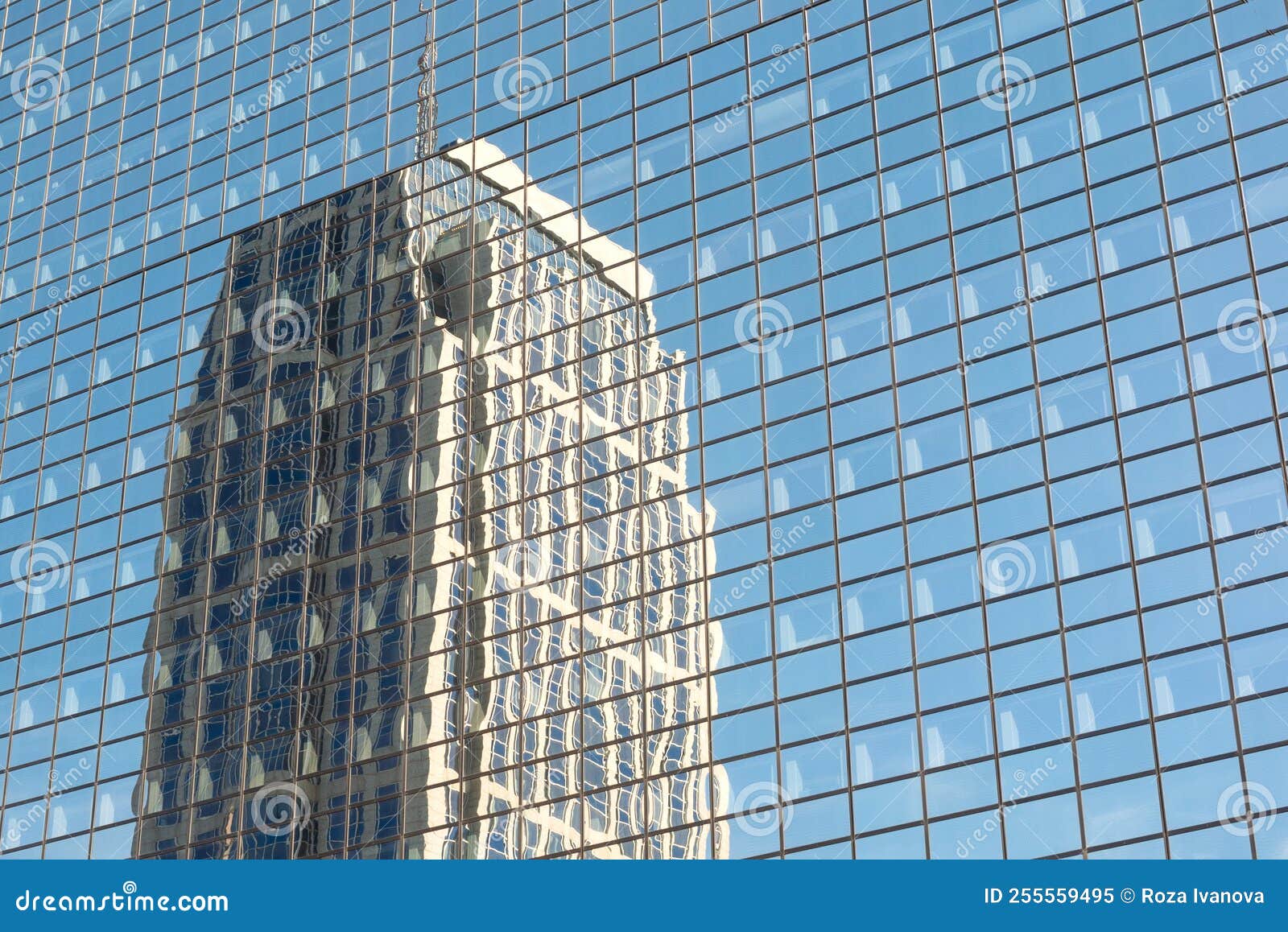 A Distorted Reflection of a Building in the Glazed Facade of Another ...