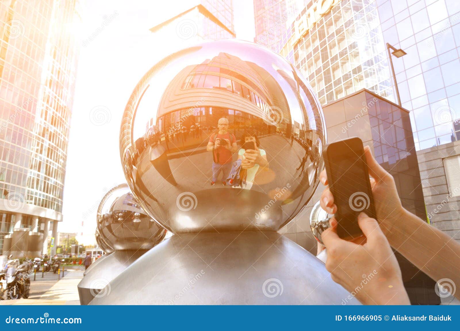 Distorted Reflection of Two People Created by a Spherical Ball, Taking ...