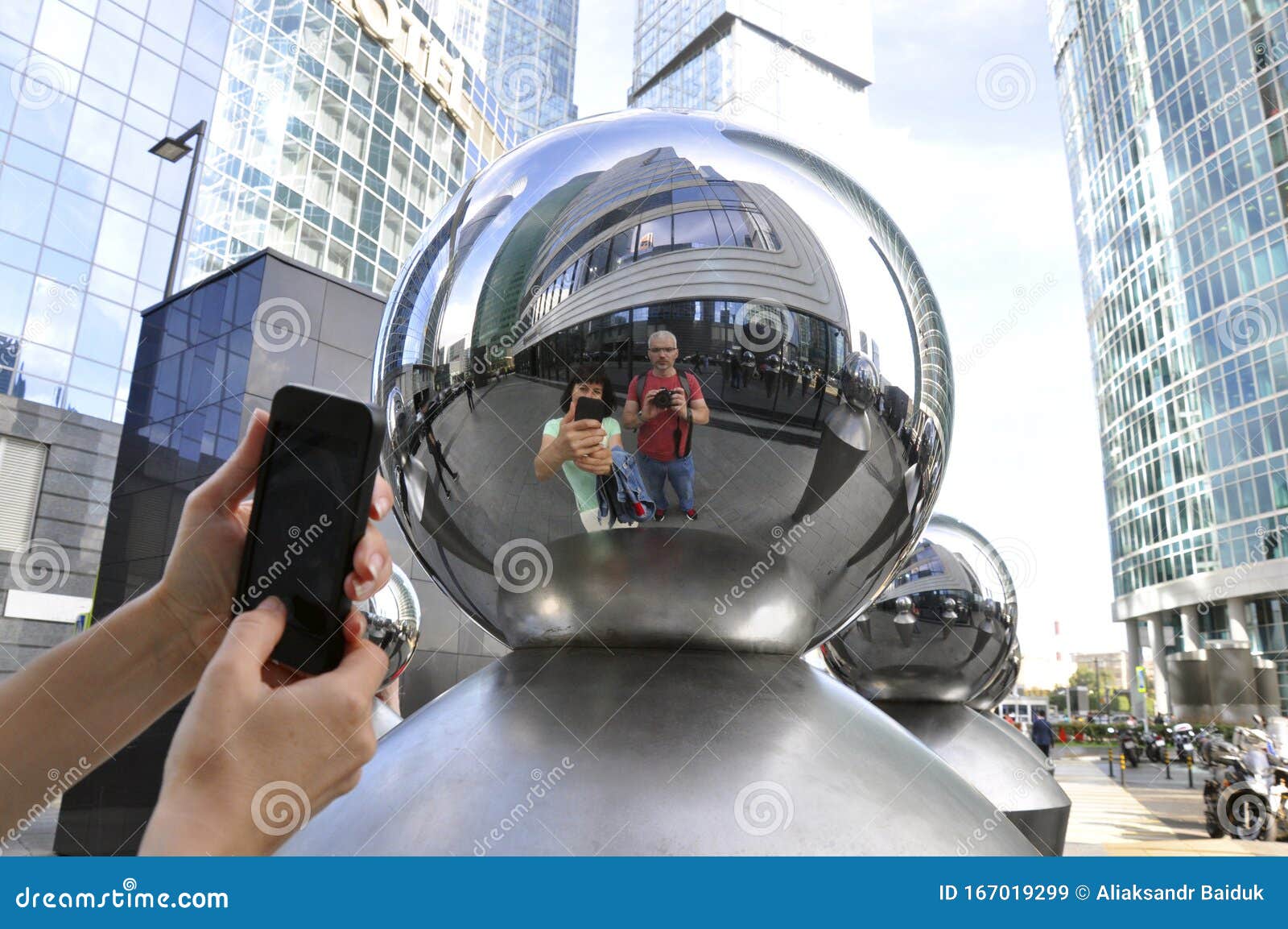 Distorted Reflection of Two People Created by a Spherical Ball, Taking ...
