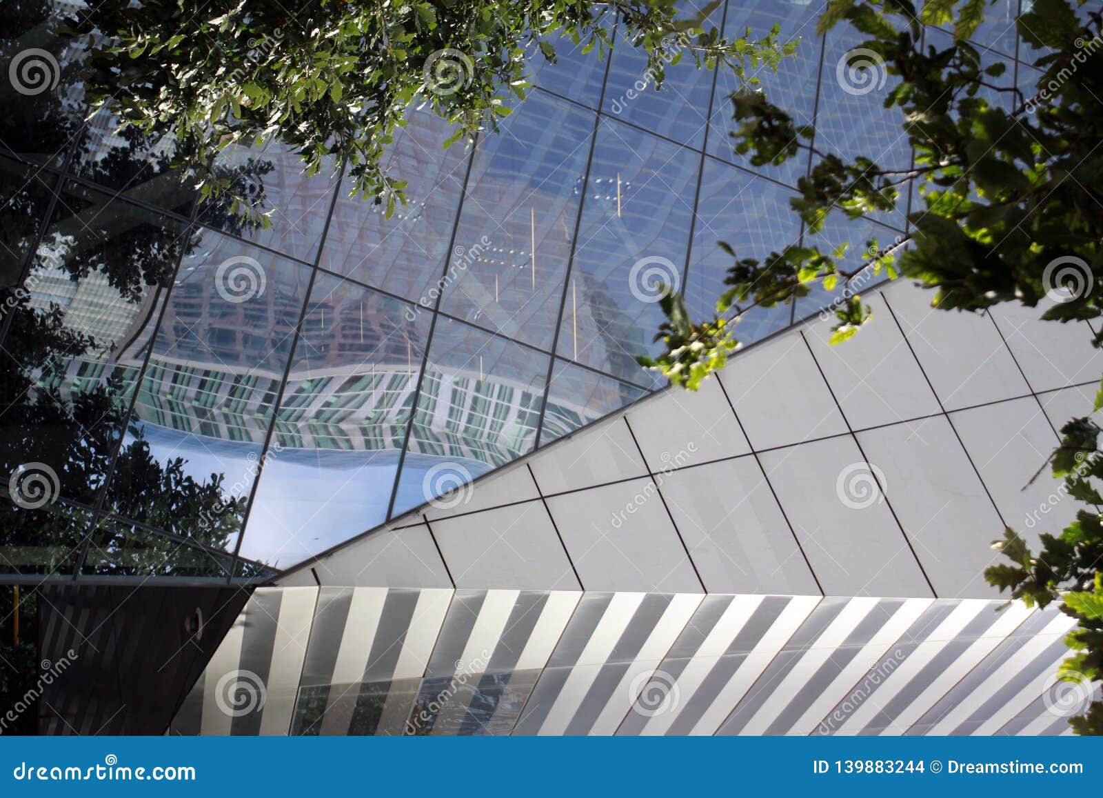 Distorted Reflections Of Skyscrapers In The Glass Facade Of A Modern ...