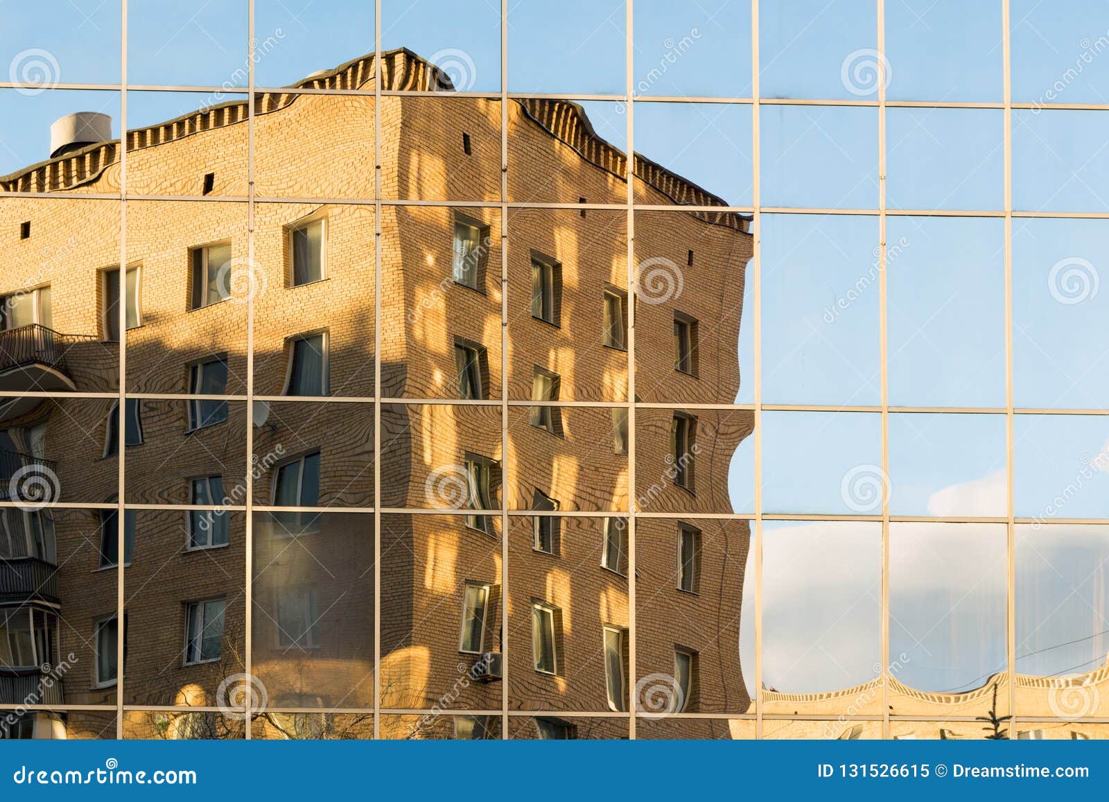 Distorted Twisted Reflection of a Brick House in the Windows of a ...