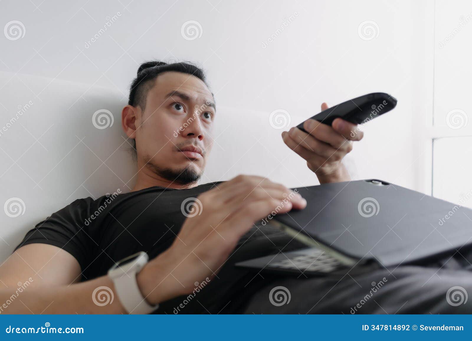 Distracted Creative Designer Man Lying on Sofa Working Watching Tv ...