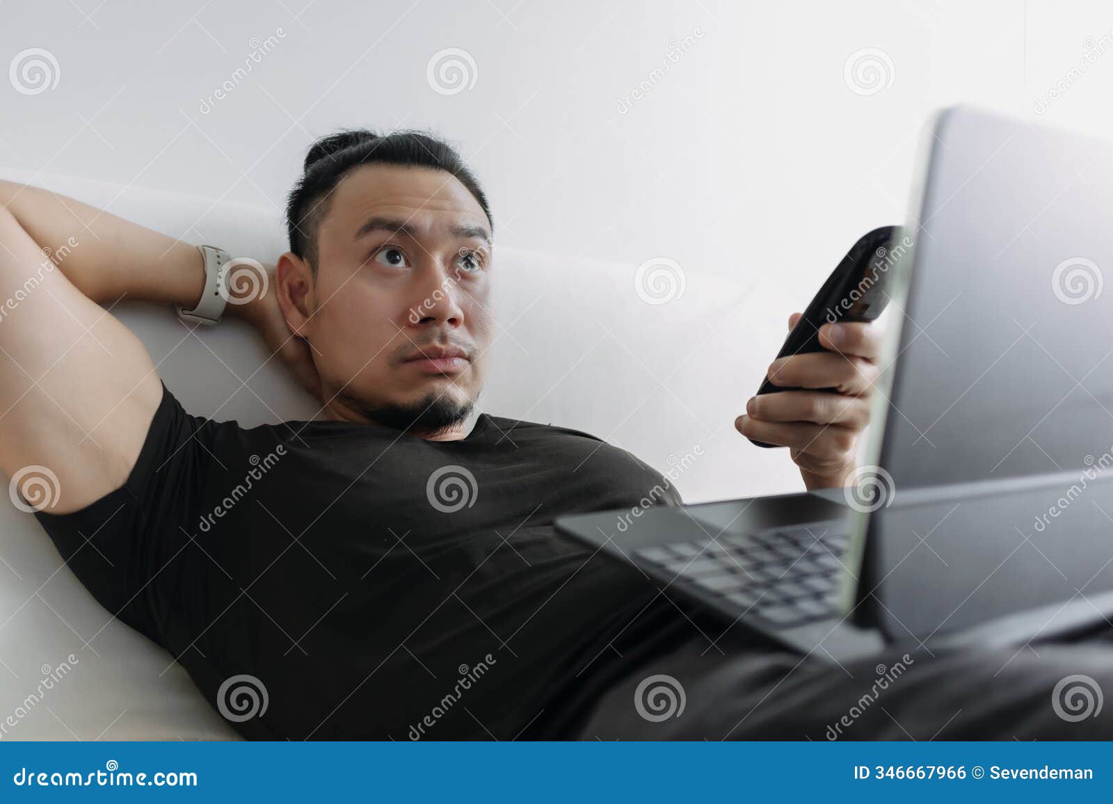 Distracted Creative Designer Man Lying on Sofa Working Watching Tv ...