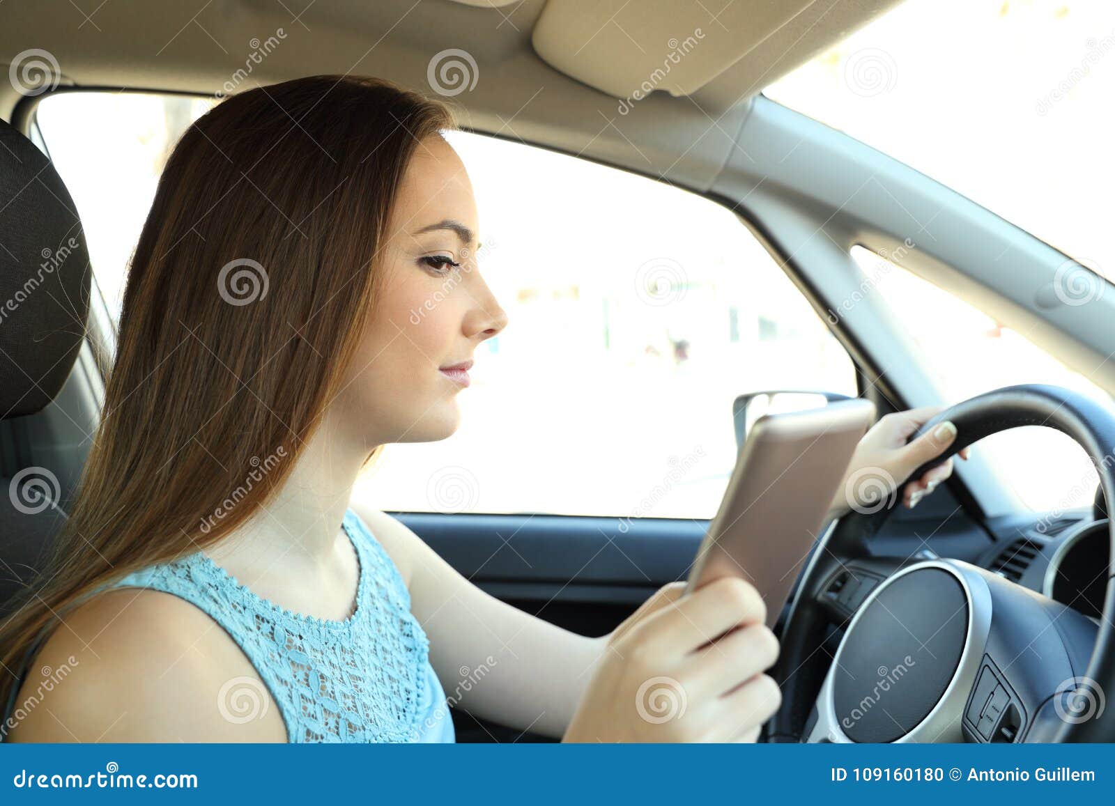 Distracted Driver Reading Phone Message Driving a Car Stock Photo ...