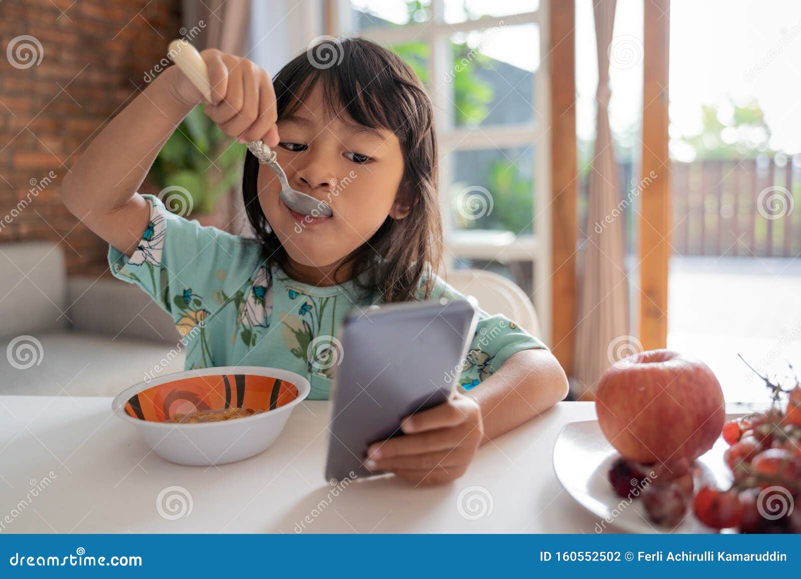 Distracted Kid Using Mobile Phone while Having Breakfast Stock Photo ...