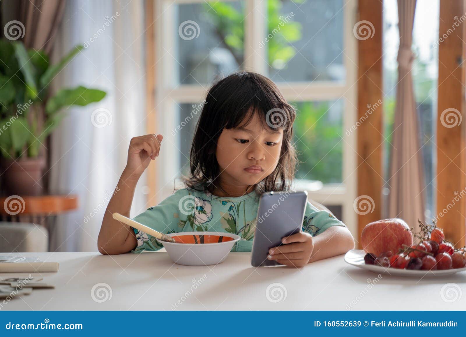 Distracted Kid Using Mobile Phone while Having Breakfast Stock Image ...