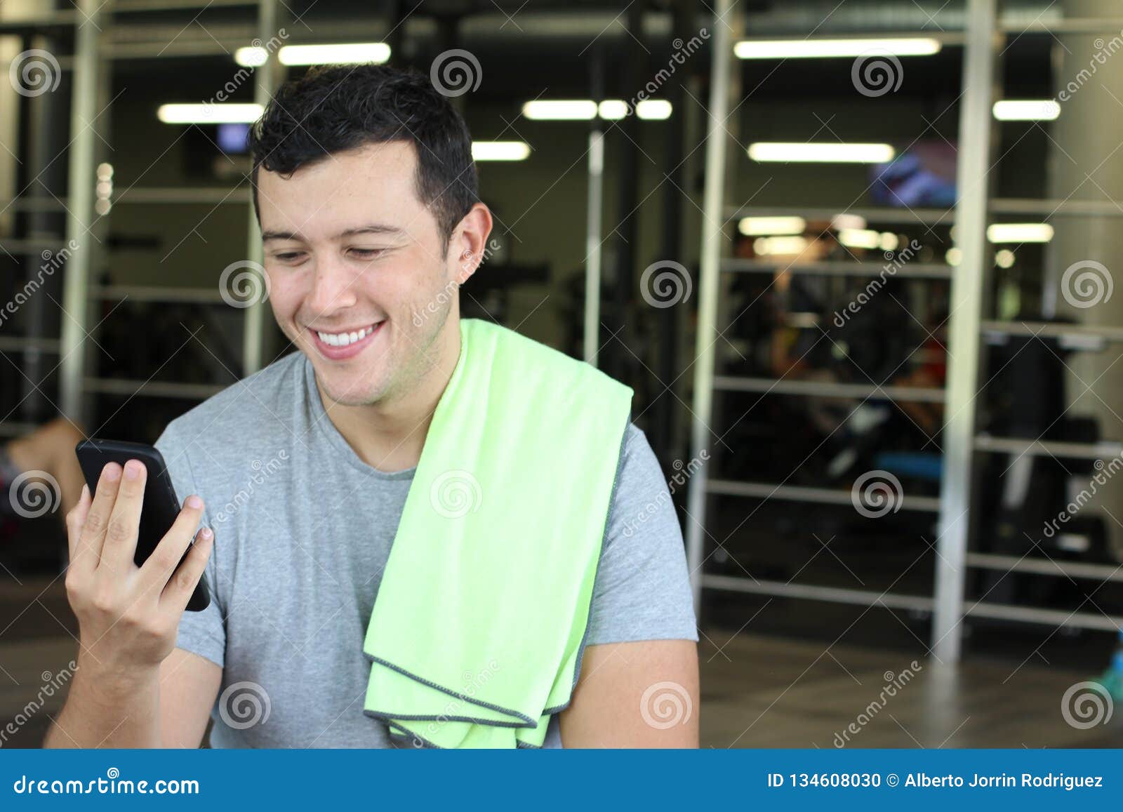 Distracted Man with Cellphone at the Gym Stock Photo - Image of ...
