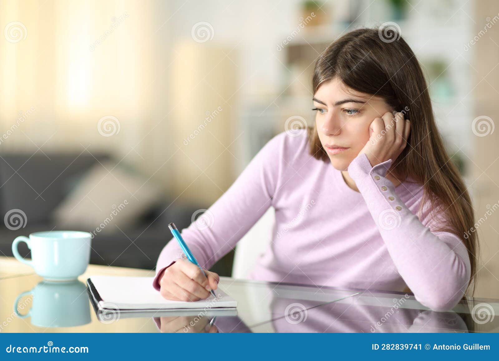 Distracted Teen Writing on Notebook at Home Stock Image - Image of ...