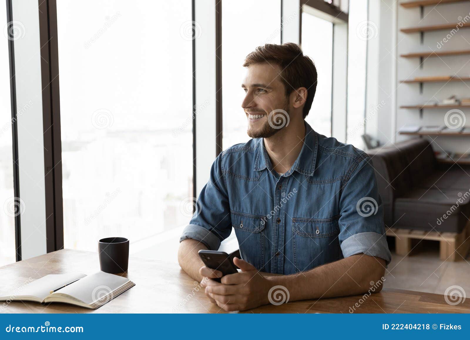 Distracted Young Man Holding Smartphone in Hands. Stock Photo - Image ...