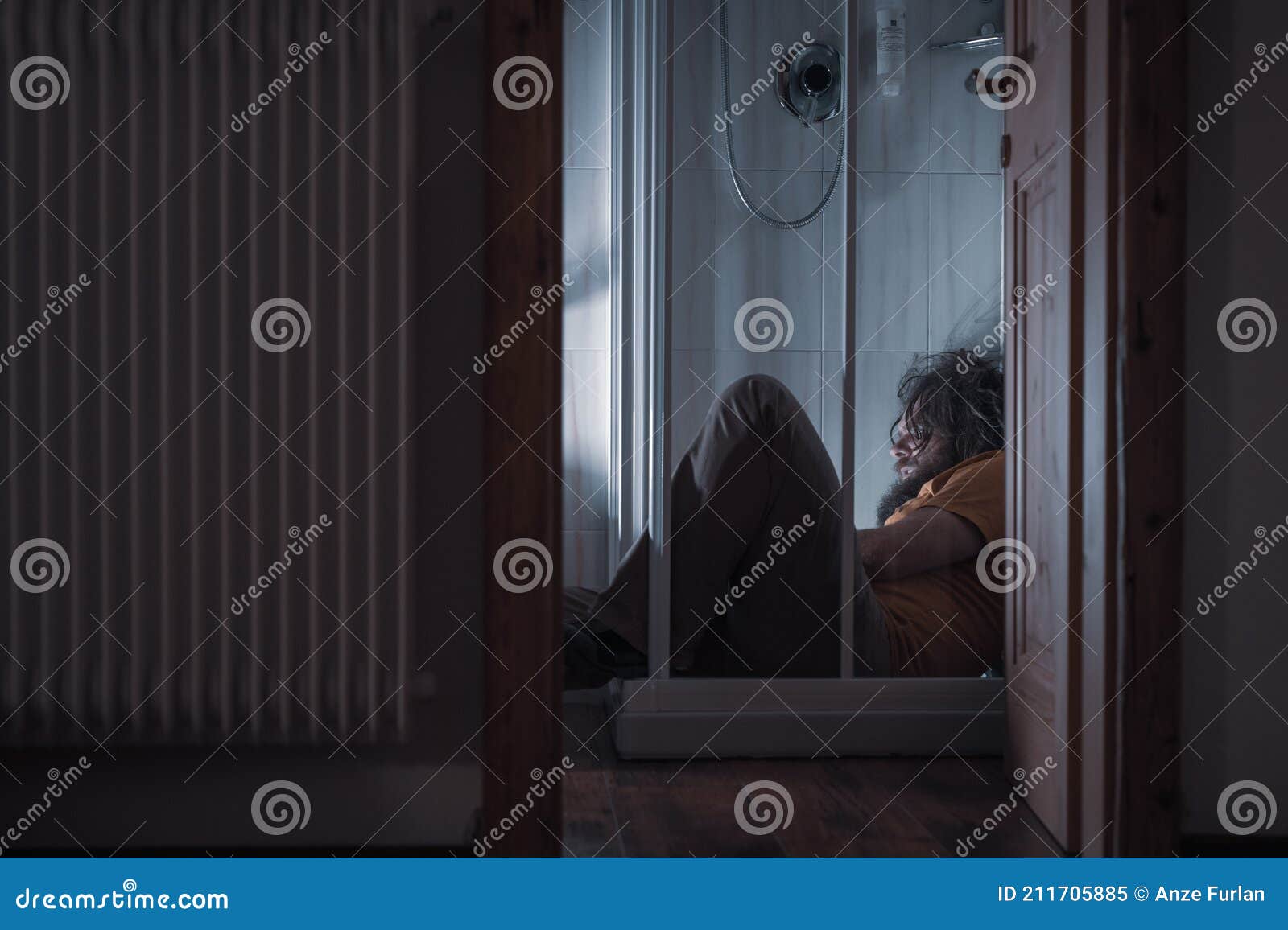 Distressed or Deranged Man Dressed Sitting in the Shower Traumatizing ...