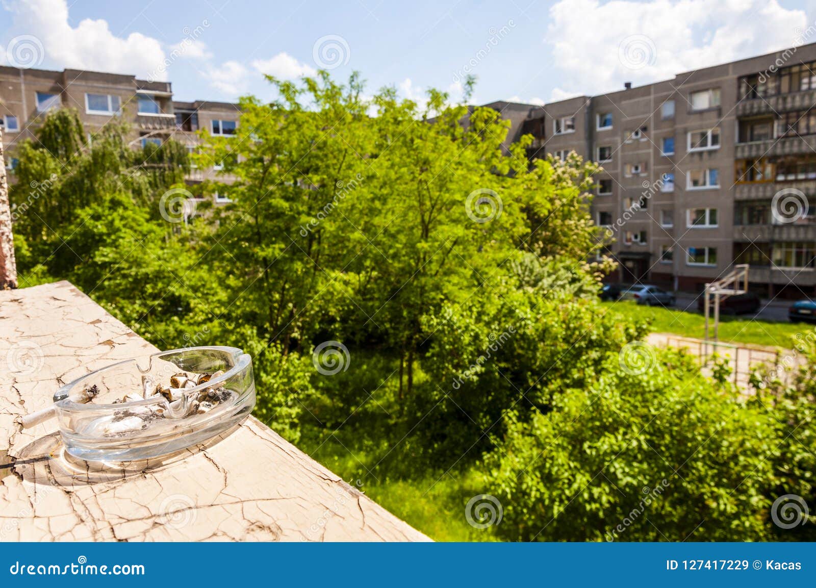 Glass Ashtray with Cigarette Butts on the Balcony Railing Stock Image ...