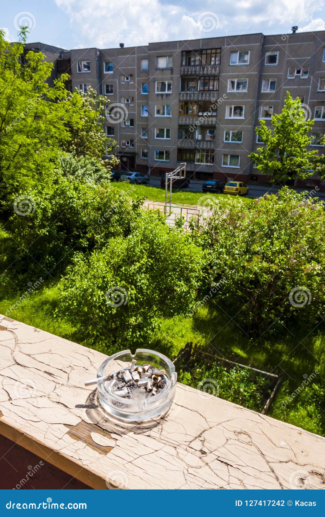 Glass Ashtray with Cigarette Butts on the Balcony Railing Stock Photo ...