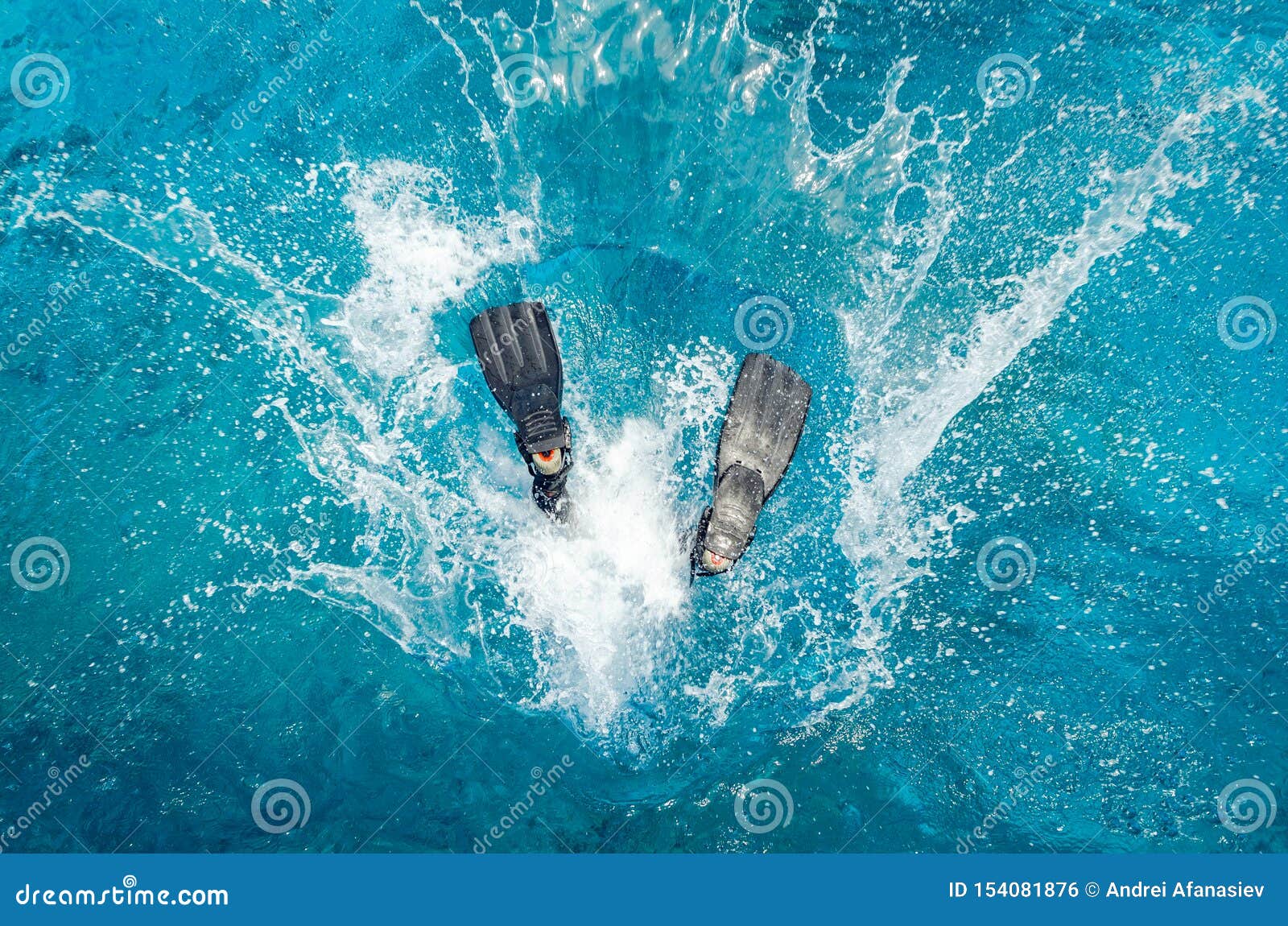 Diver in a Wetsuit and Flippers Jumping in the Blue Water Stock Photo ...