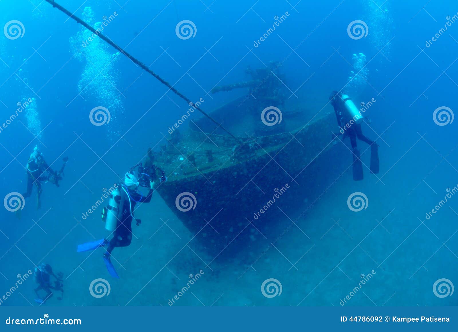 Divers Exploring the Ship Wreck in Tropical Sea Stock Photo - Image of ...
