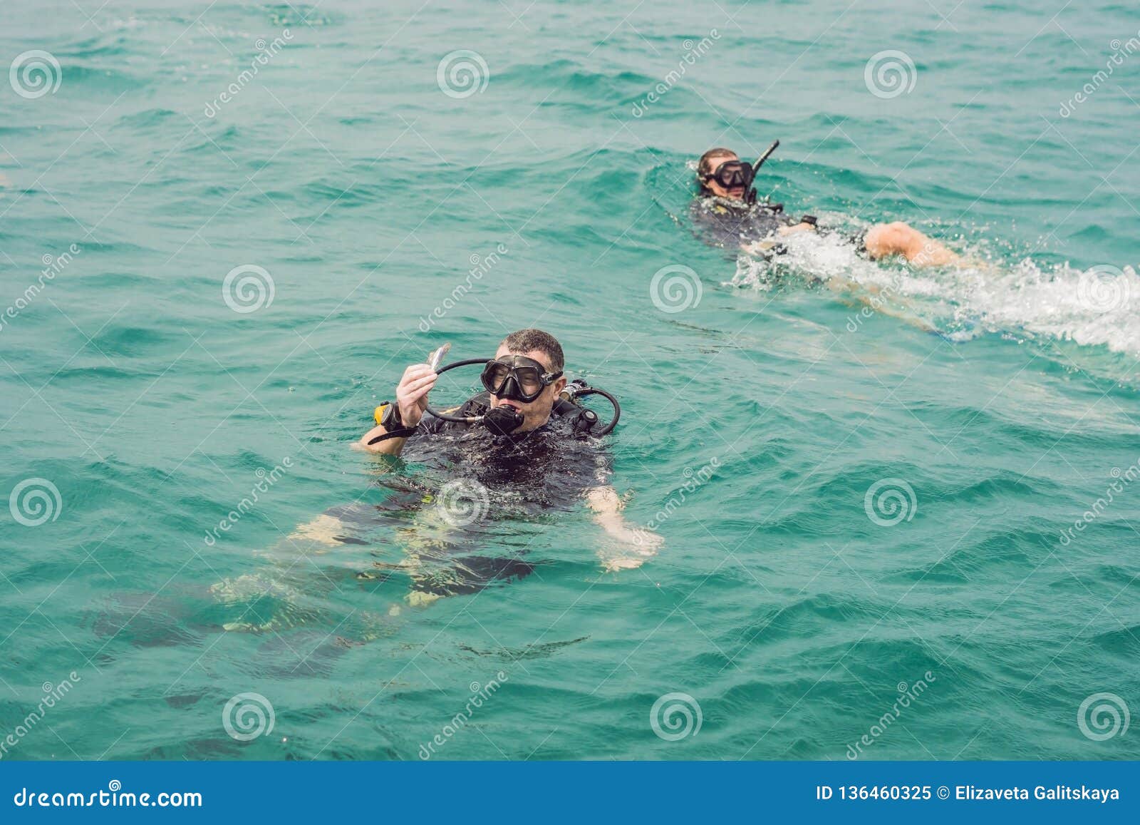 Divers on the Surface of Water Ready To Dive Stock Image - Image of ...