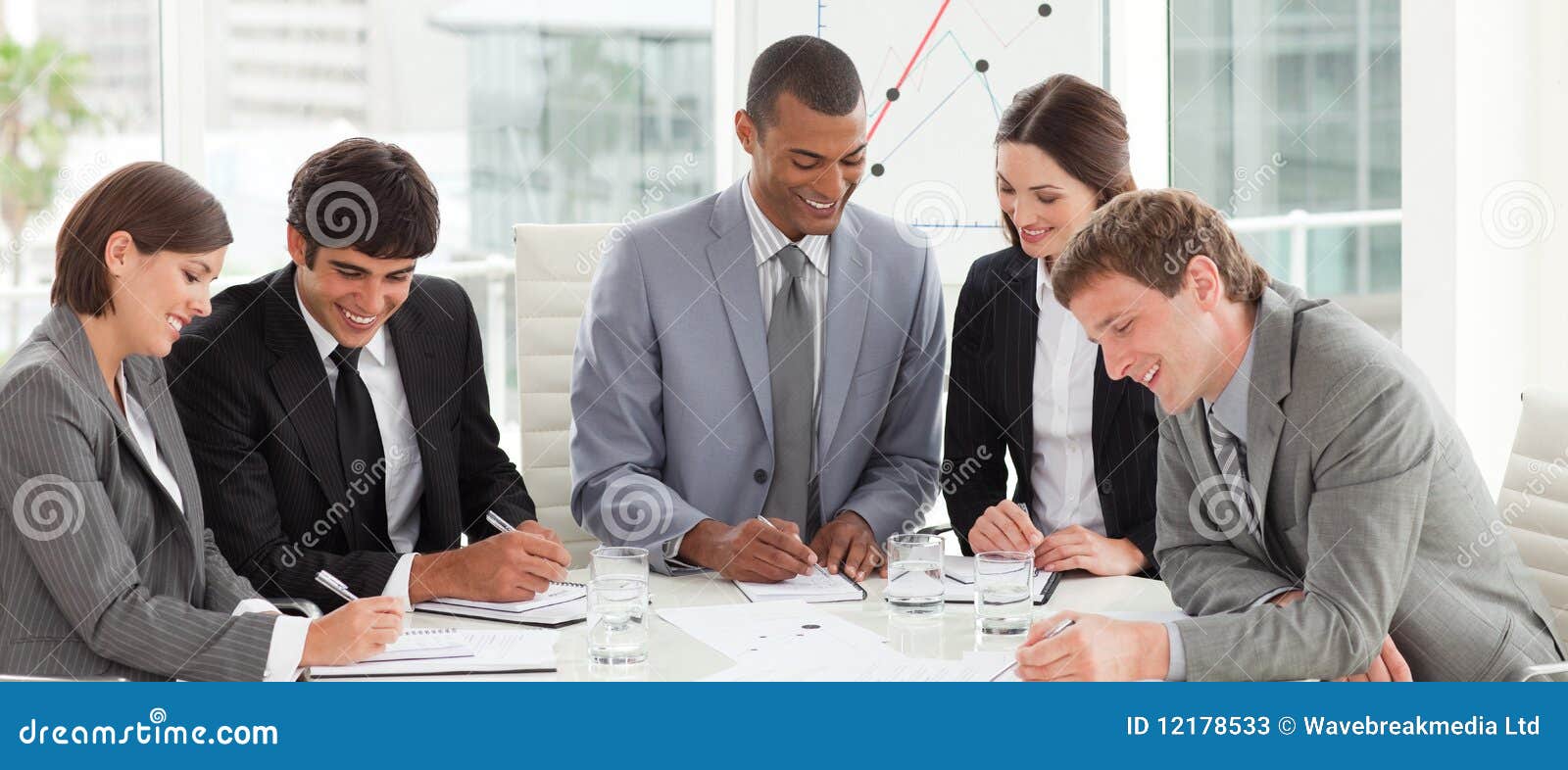A Diverse Business Group Studying a Budget Plan Stock Image - Image of ...