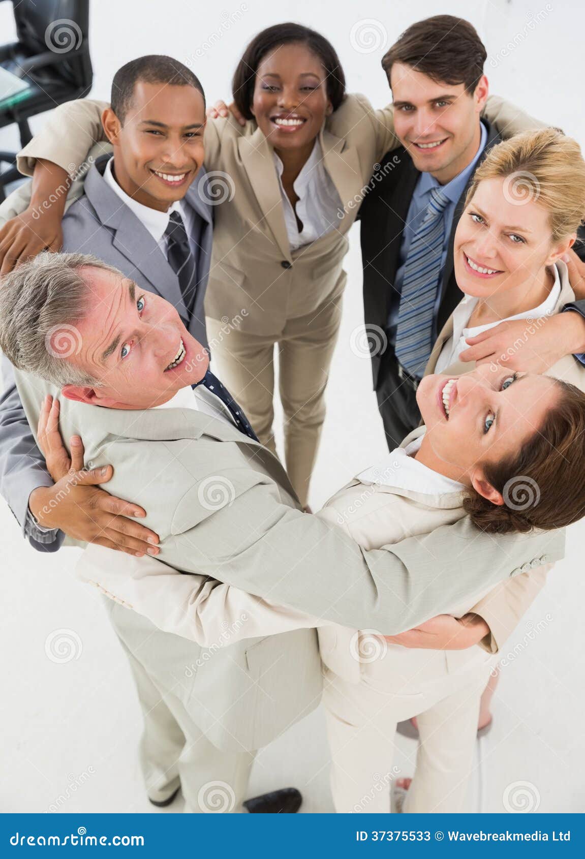Diverse Business Team Hugging in a Circle Smiling at Camera Stock Image ...
