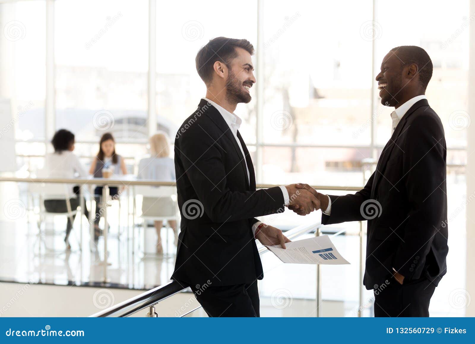 Diverse Businessmen Shaking Hands Introducing Standing in Modern Stock ...
