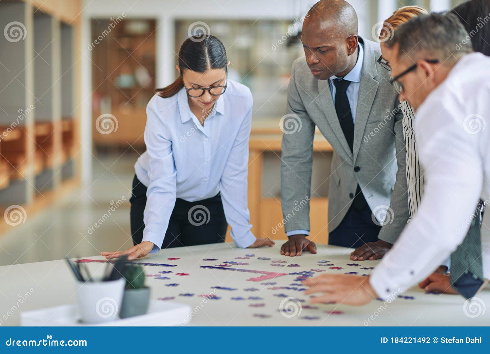 Diverse Businesspeople Solving a Jigsaw Puzzle Together at Work Stock ...