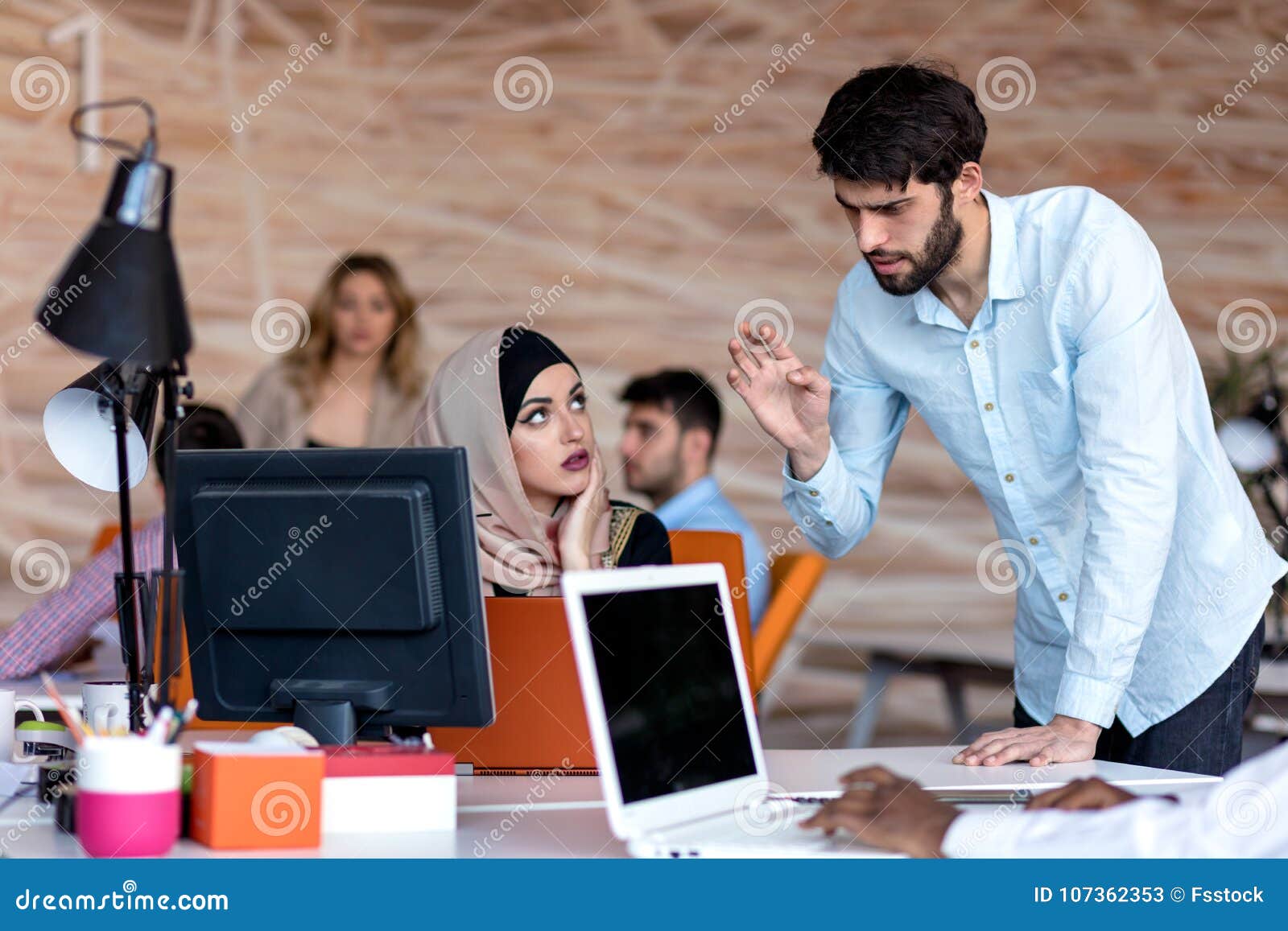 Diverse College Students Using Laptop and Talking, Learning Exchanging ...