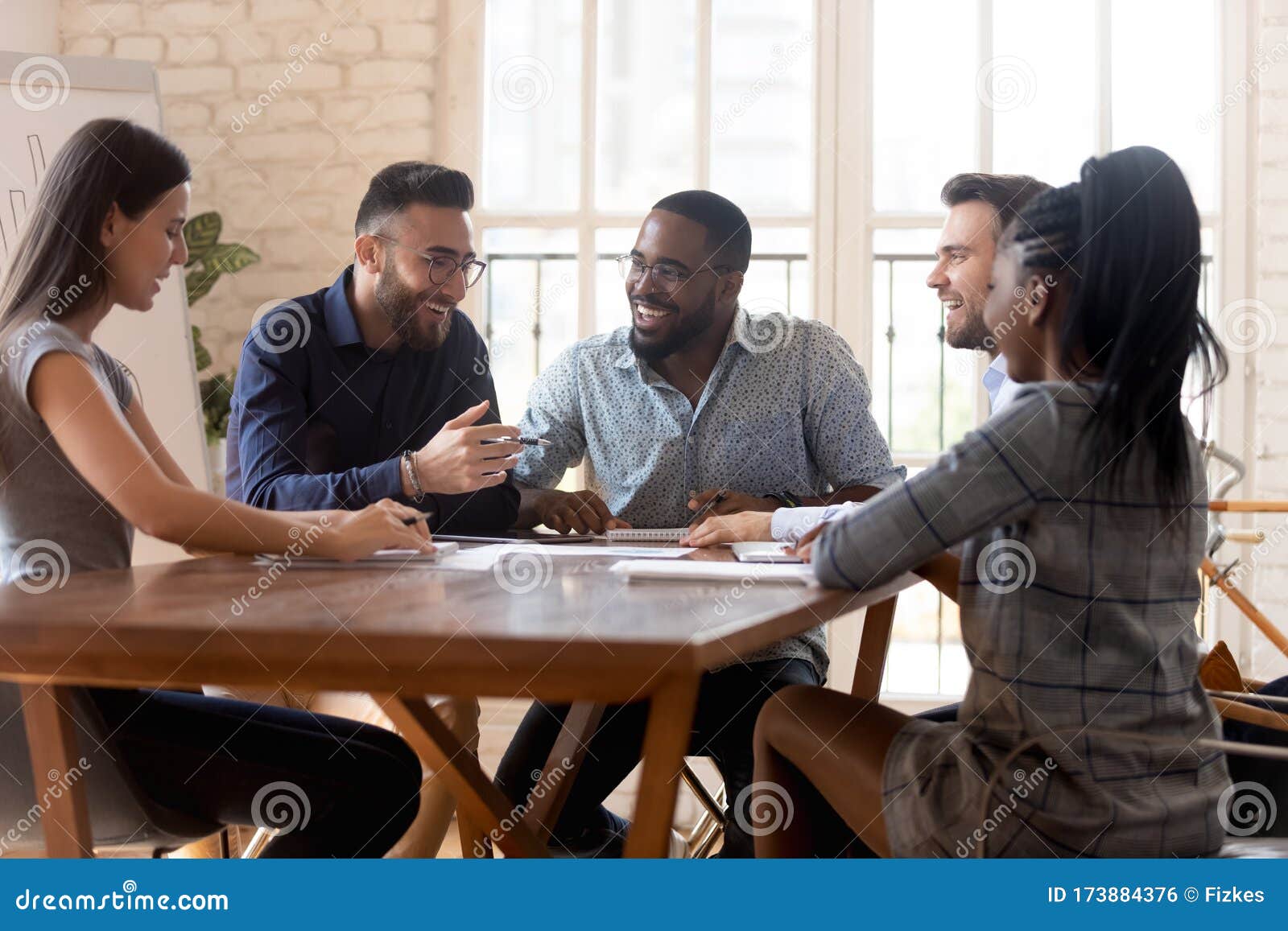 Diverse Employees Sitting at Table Having Pleasant Positive ...