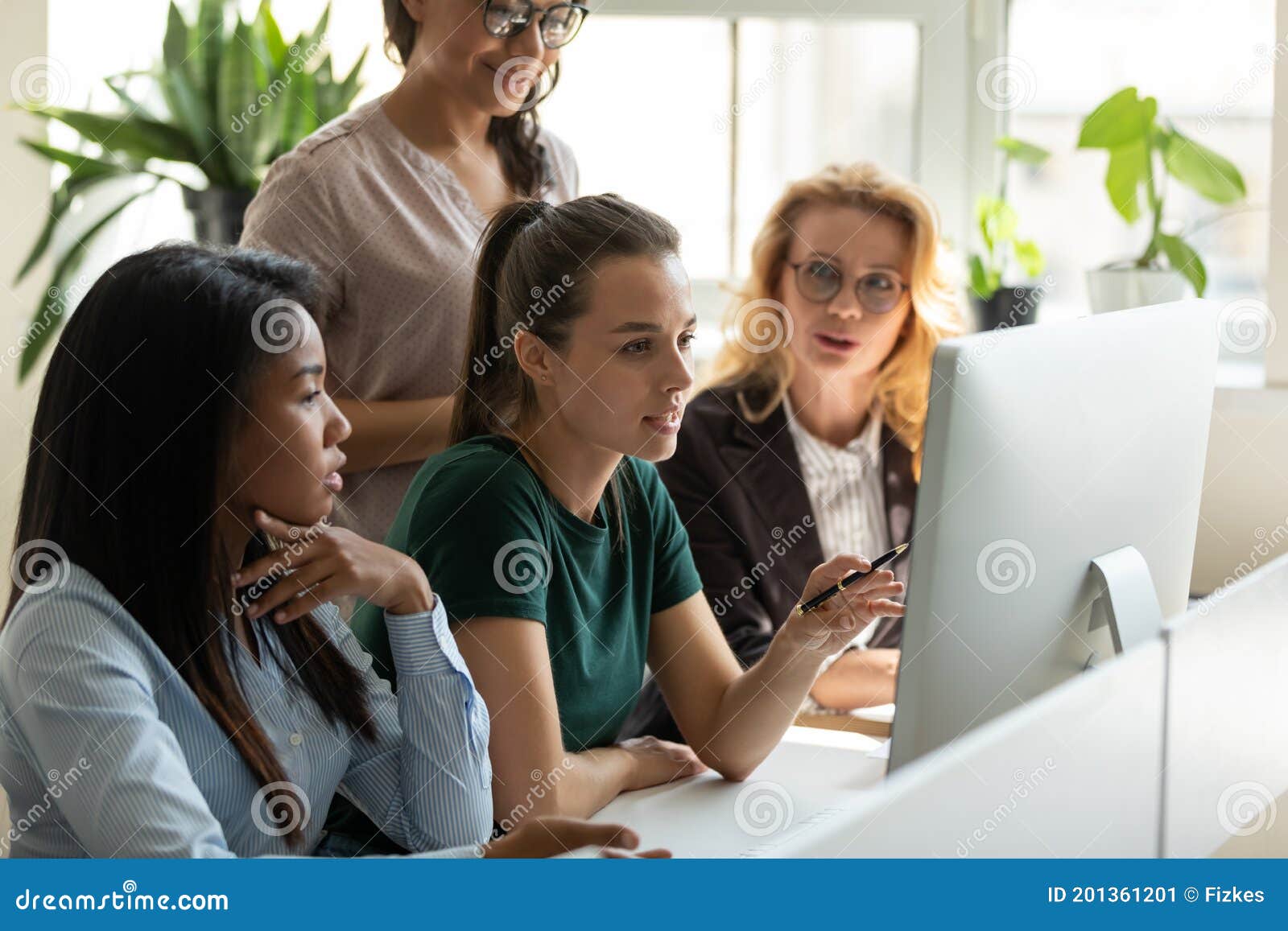 Diverse Female Office Workers Looking at Computer Screen Listening ...