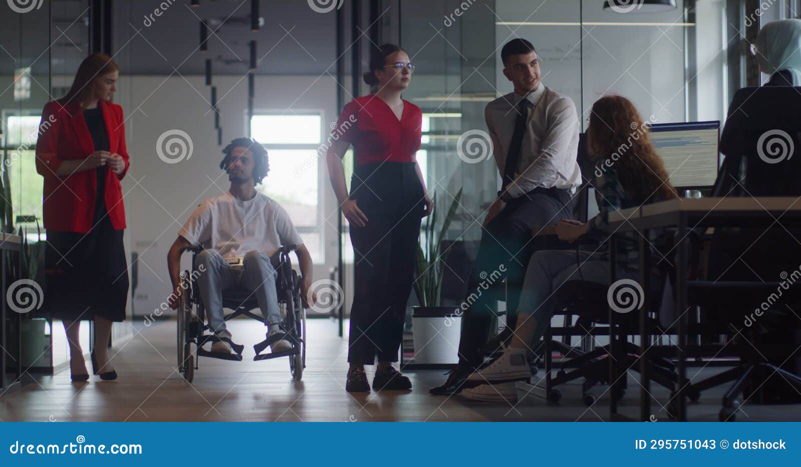 A Diverse Group of Business Colleagues Engage in Discussions about ...