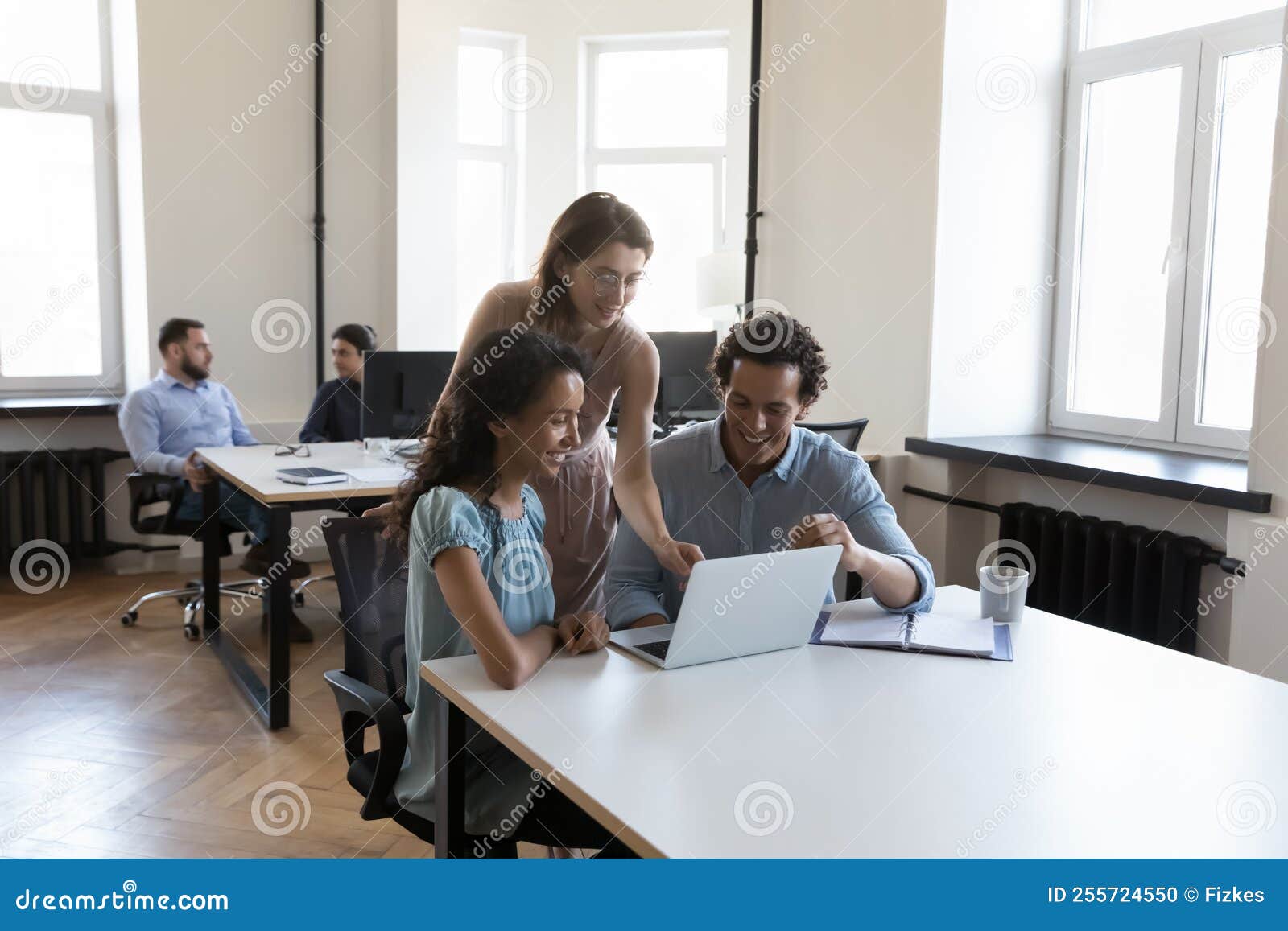 Diverse Group of Cheerful Employees Sharing Computer at Office Table ...