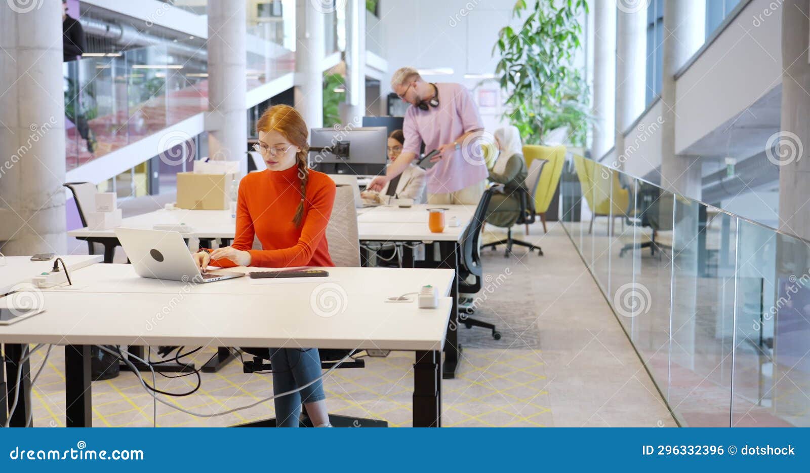 A Diverse Group of Colleagues Collaborates in Modern Offices ...