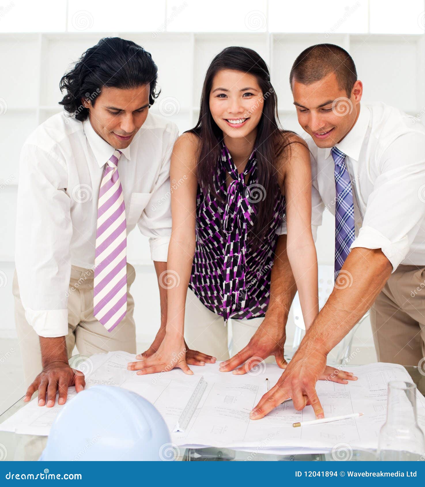 A Diverse Group of Engineers Reviewing Blueprints Stock Photo - Image ...