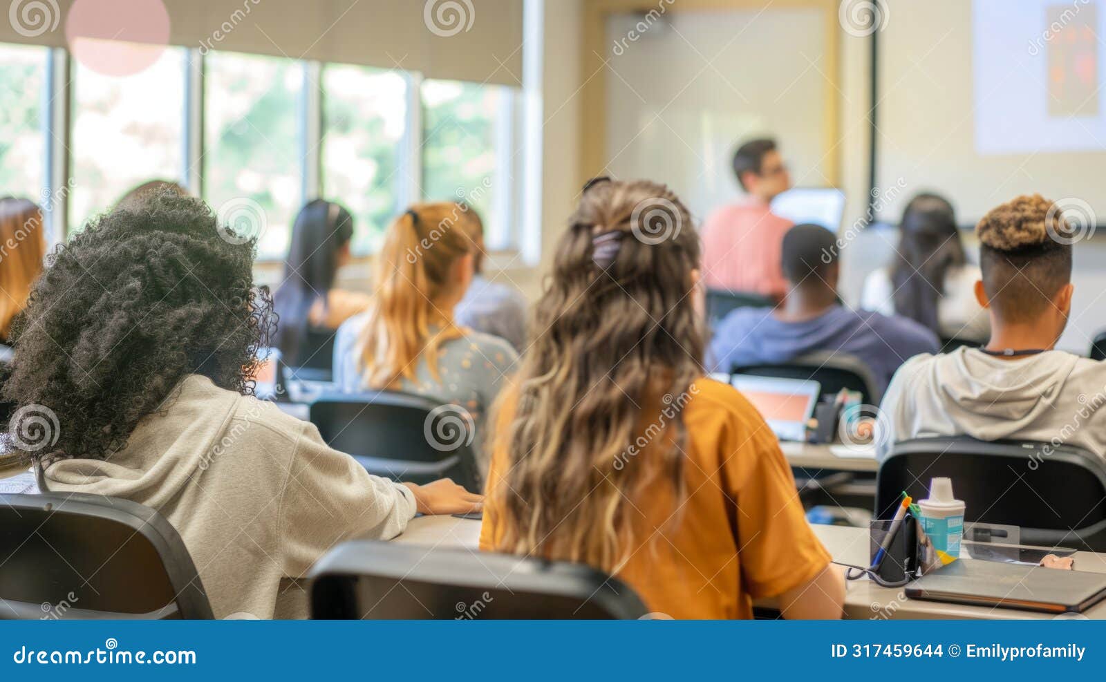 Group of People Sitting at Desks in a Classroom Stock Photo - Image of ...
