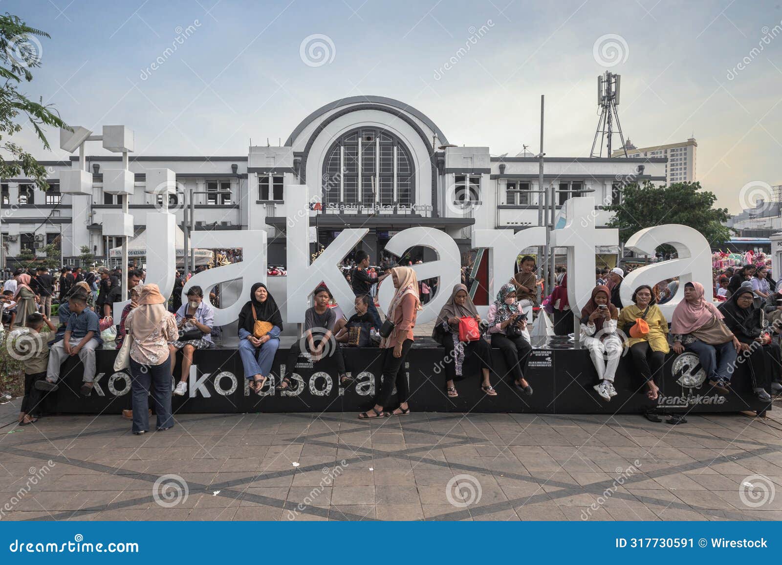 Diverse Group of Individuals Sitting on a Street Editorial Photo ...