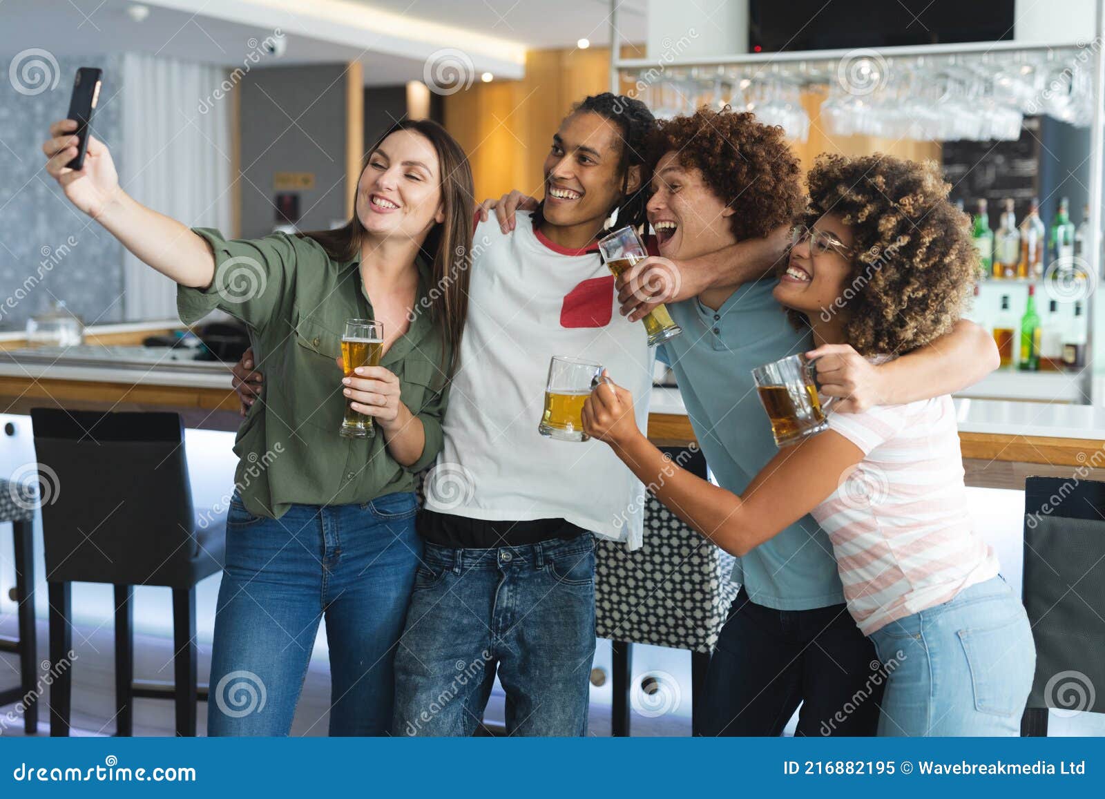 Diverse Group Of Male And Femalefriends Raising Glasses And Taking