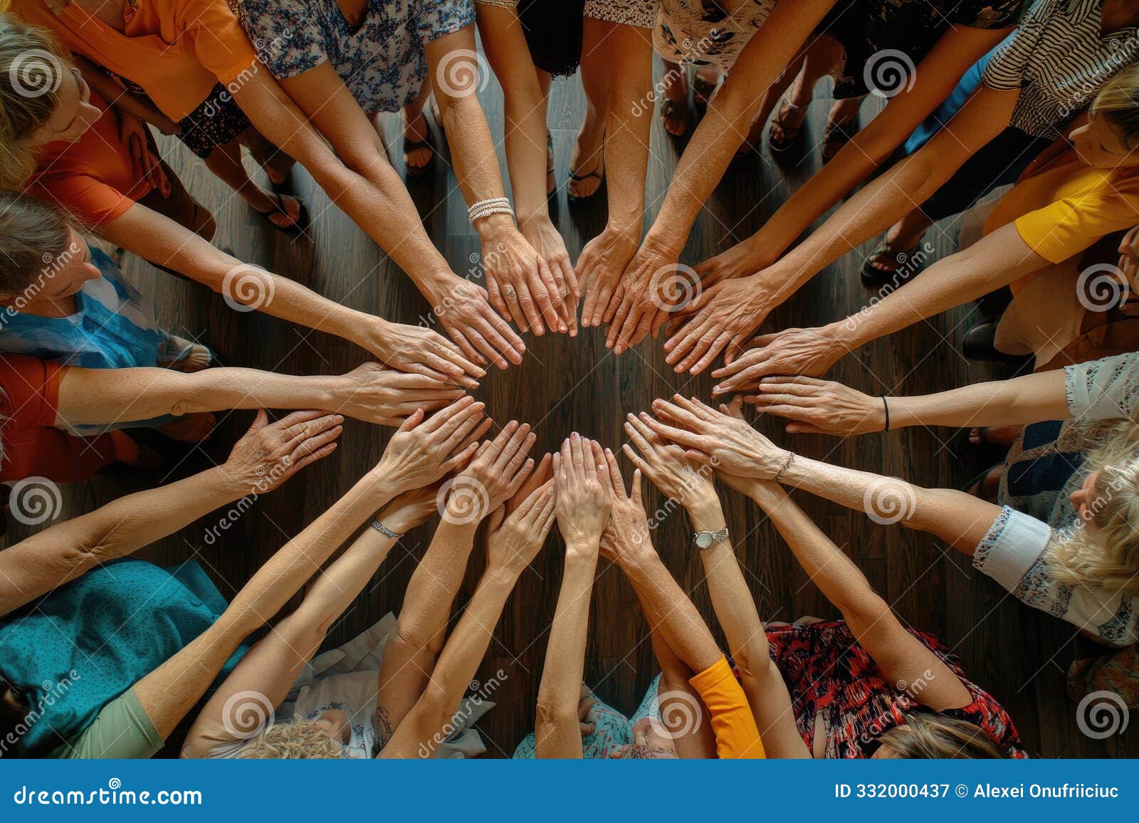 A Larger Group of Diverse People are Putting Their Hands Together in a ...
