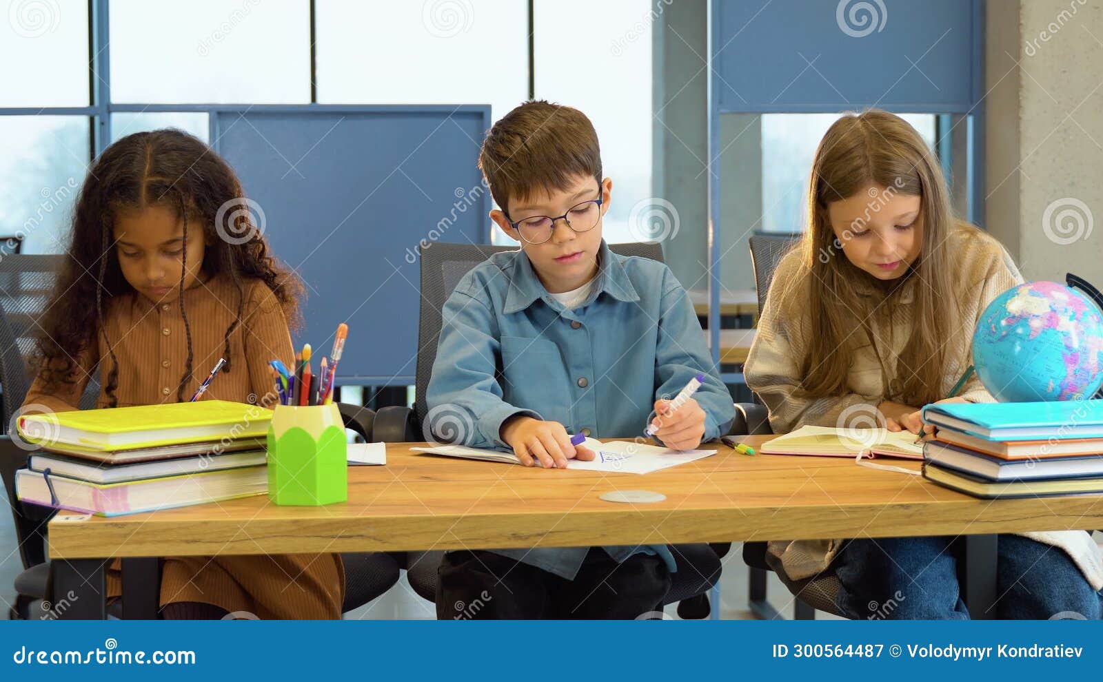 Diverse Group of School Kids with Pens and Notebooks Writing Test in ...