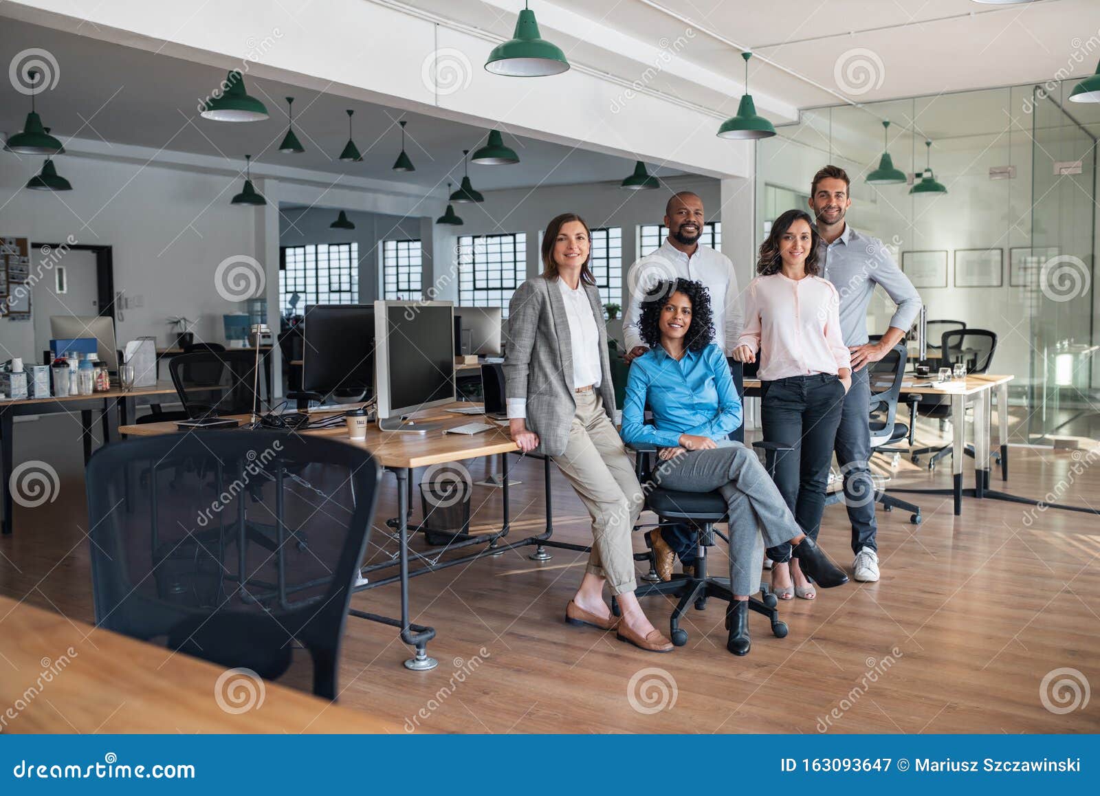Diverse Group of Smiling Businesspeople Working in an Office Stock ...
