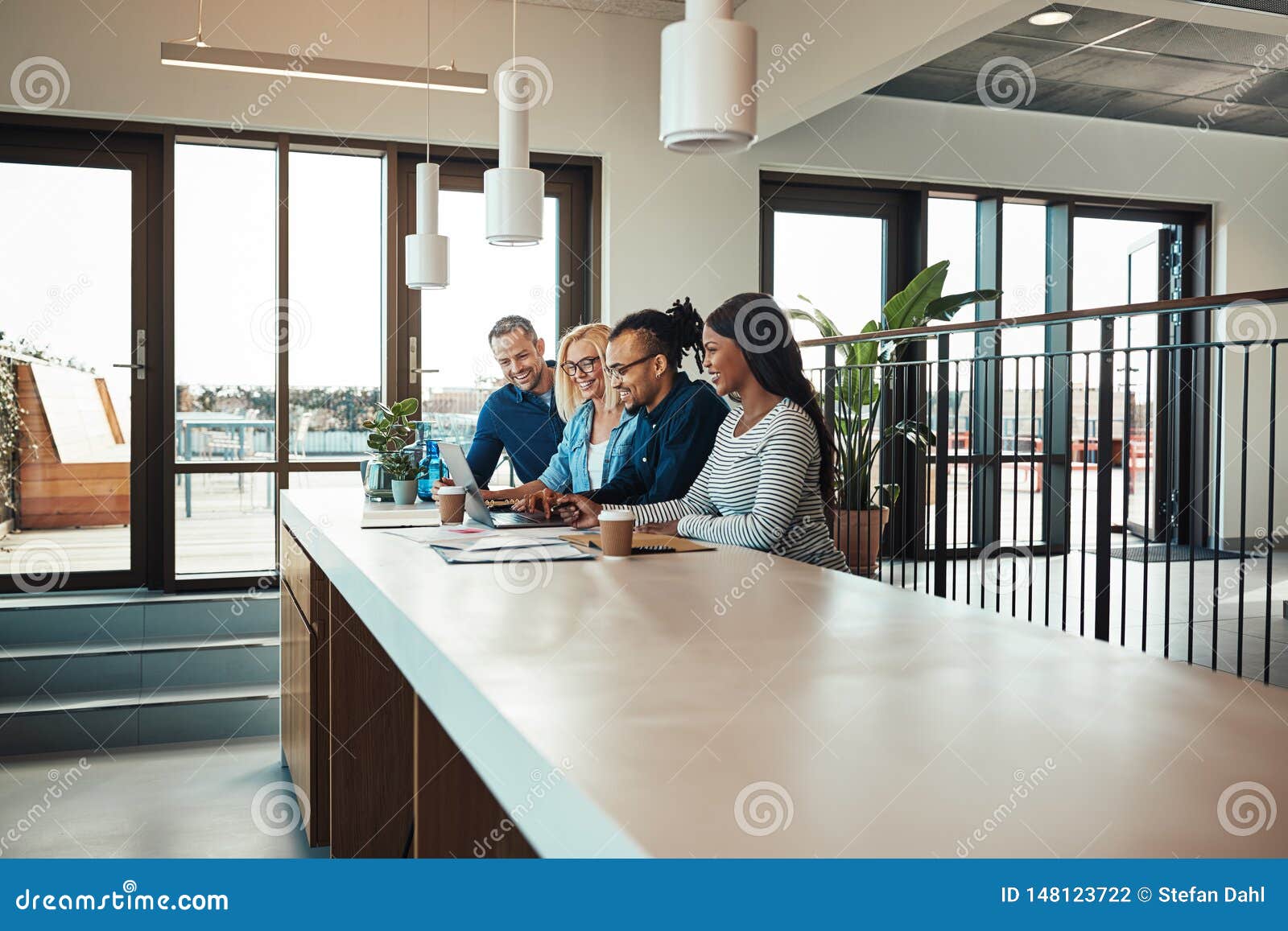 Smiling Office Colleagues Working Together on a Laptop Stock Photo ...